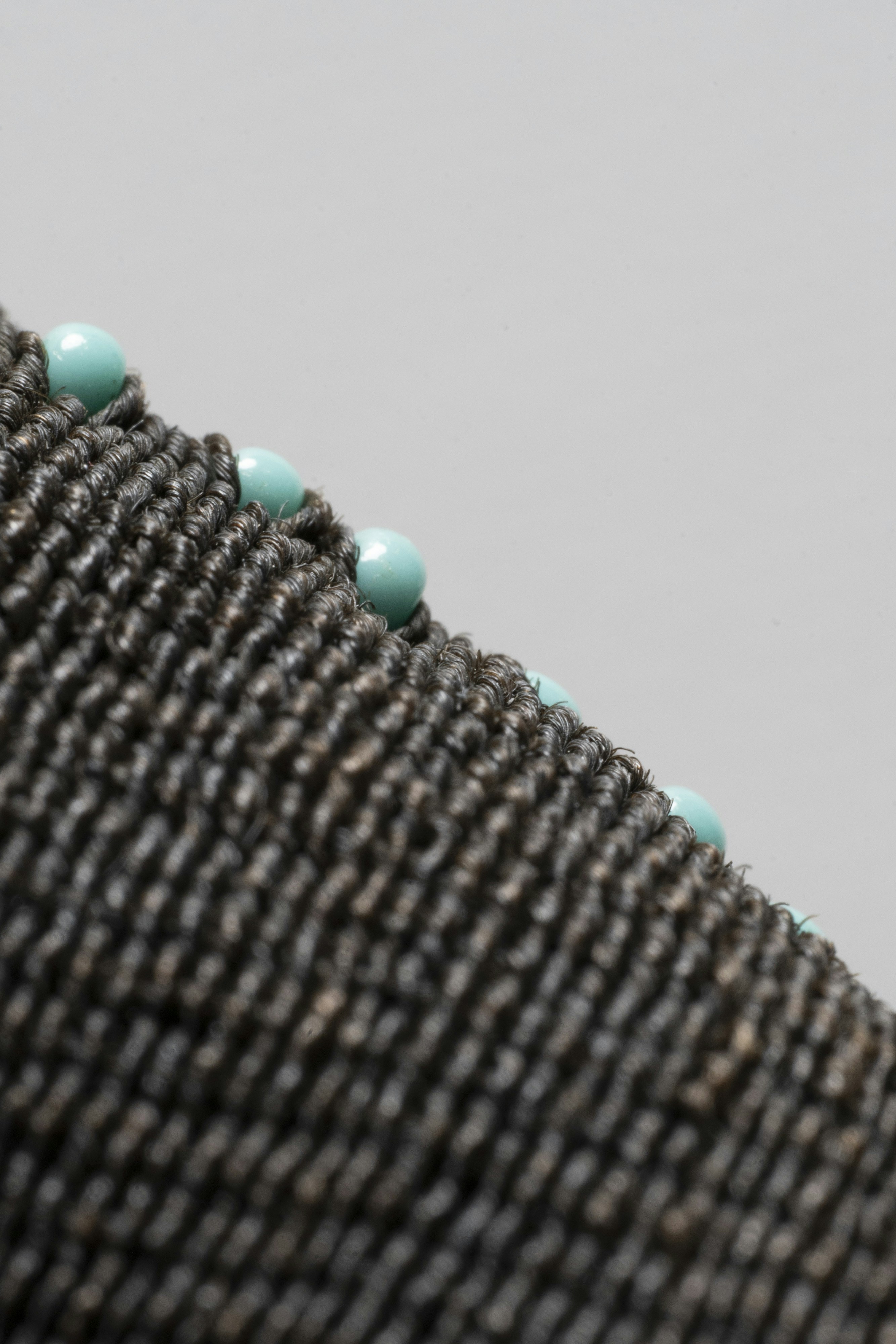 Diagonal Knit: Bead-tipped Fabric Texture Under Close Macro
