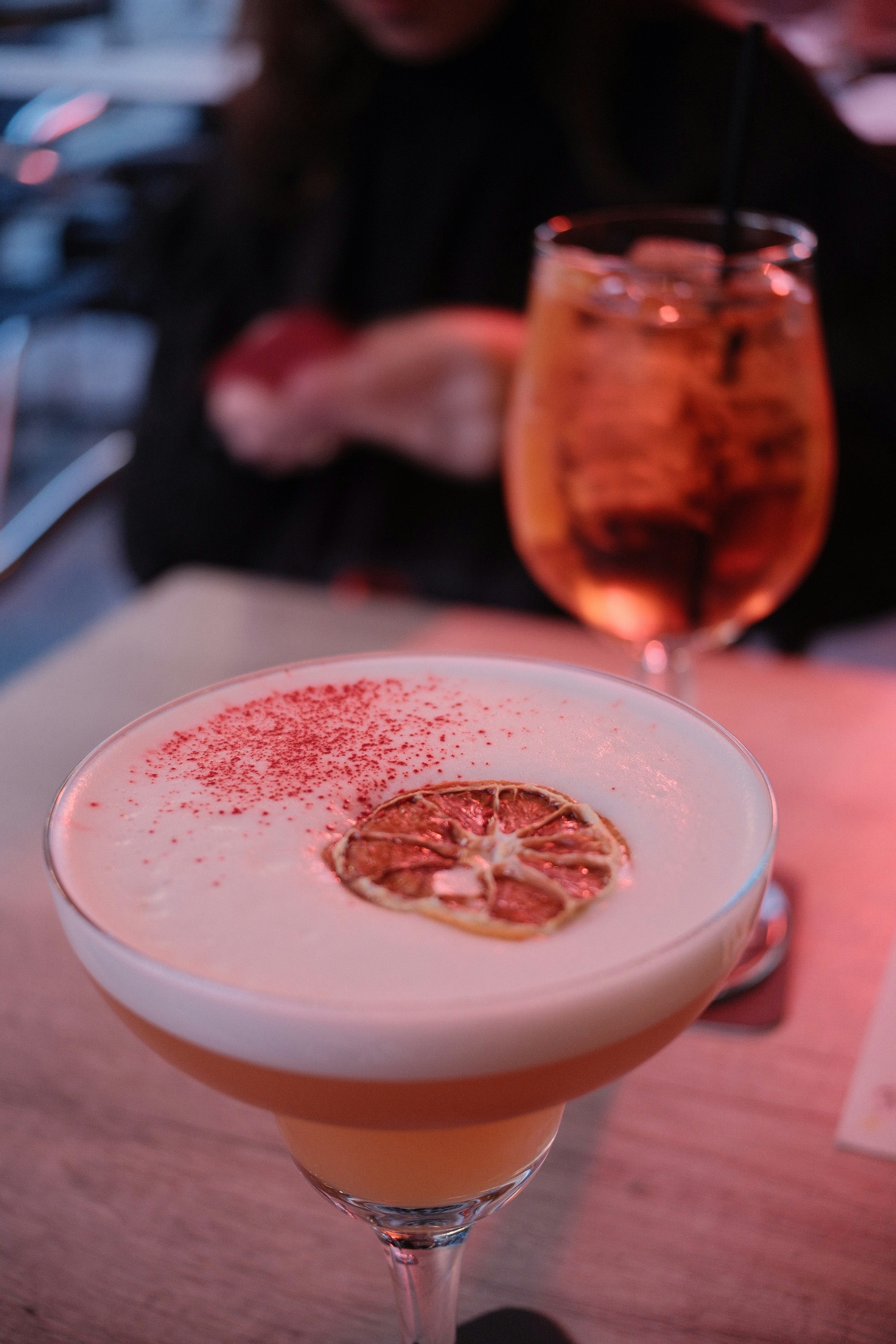 Dramatic Citrus Kiss: A Cocktail Moment in Neon-Soft Light