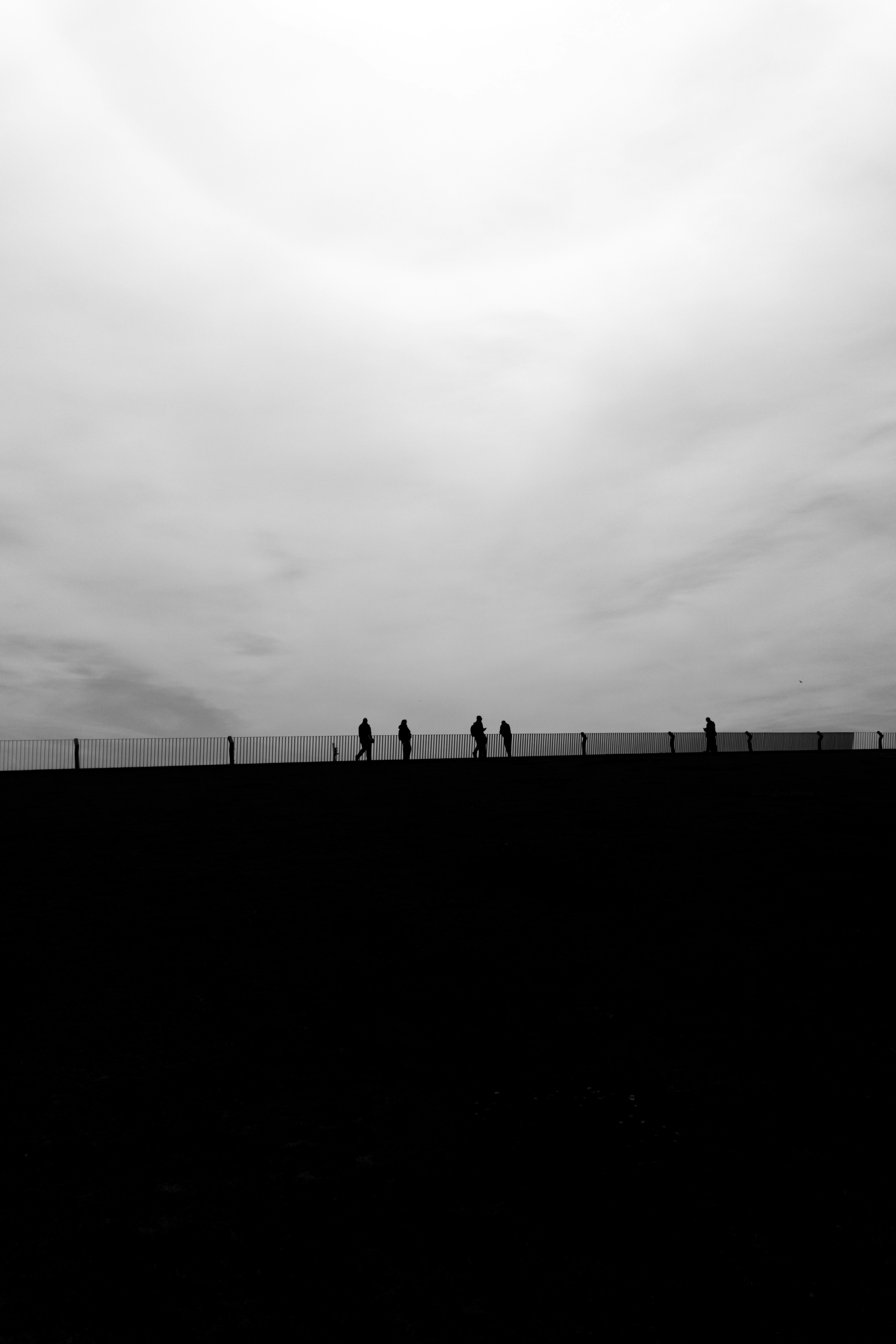 Silhouetted Figures Along a Distant Horizon
