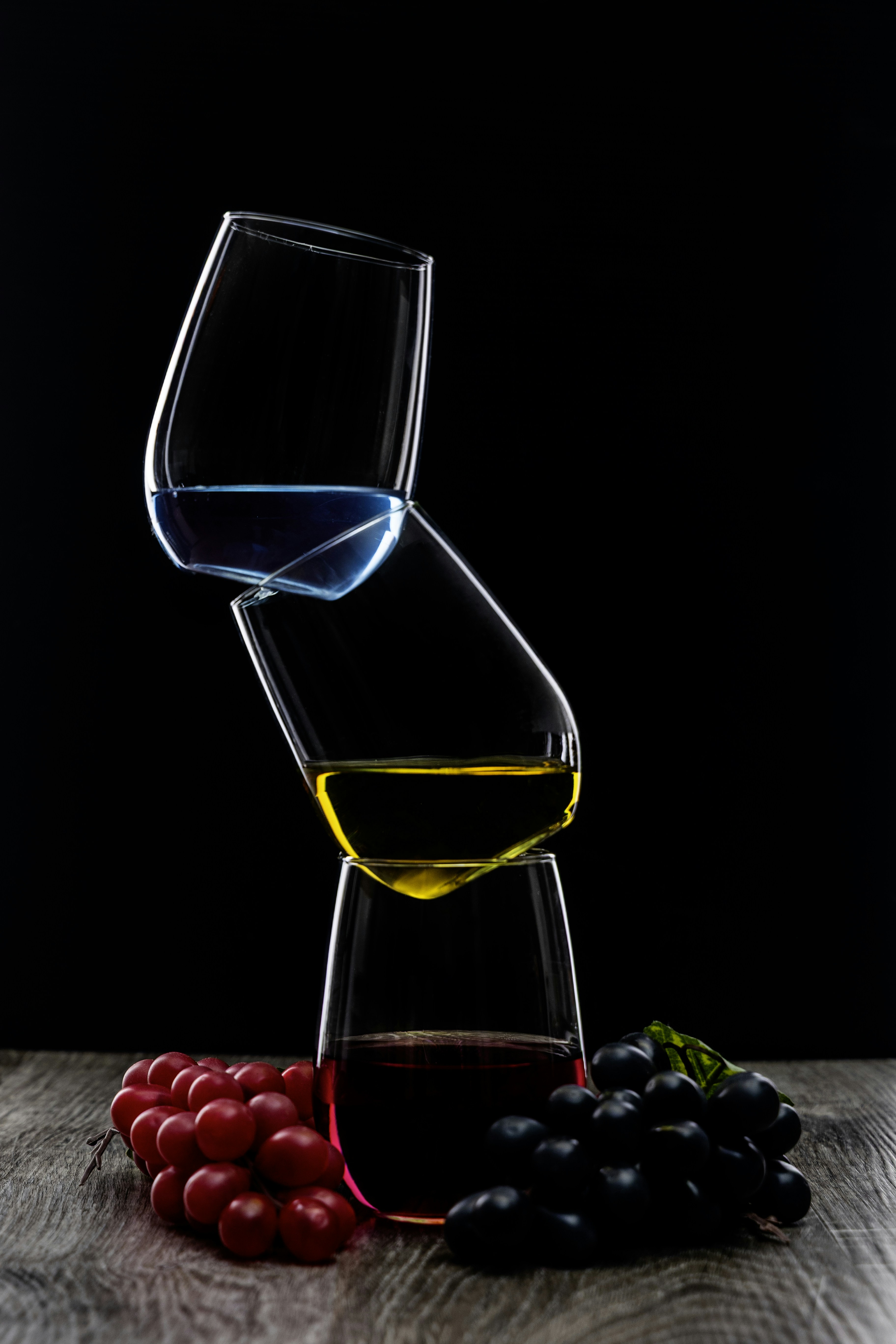 Balancing Act: Stacked Glasses of Colorful Wine