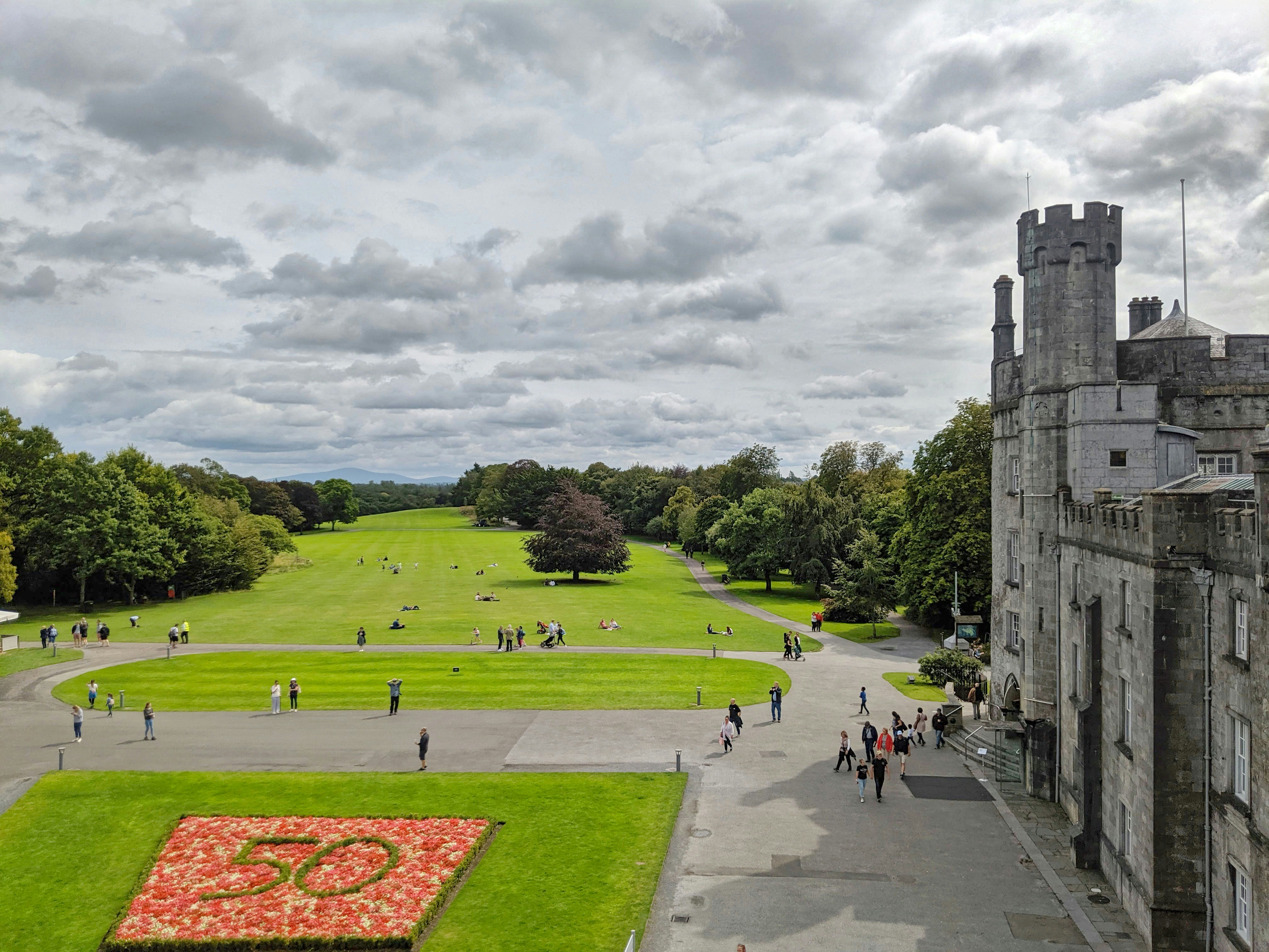 Castle Grounds: A Sunlit Lawn Framed by a Stark Garrison Wall