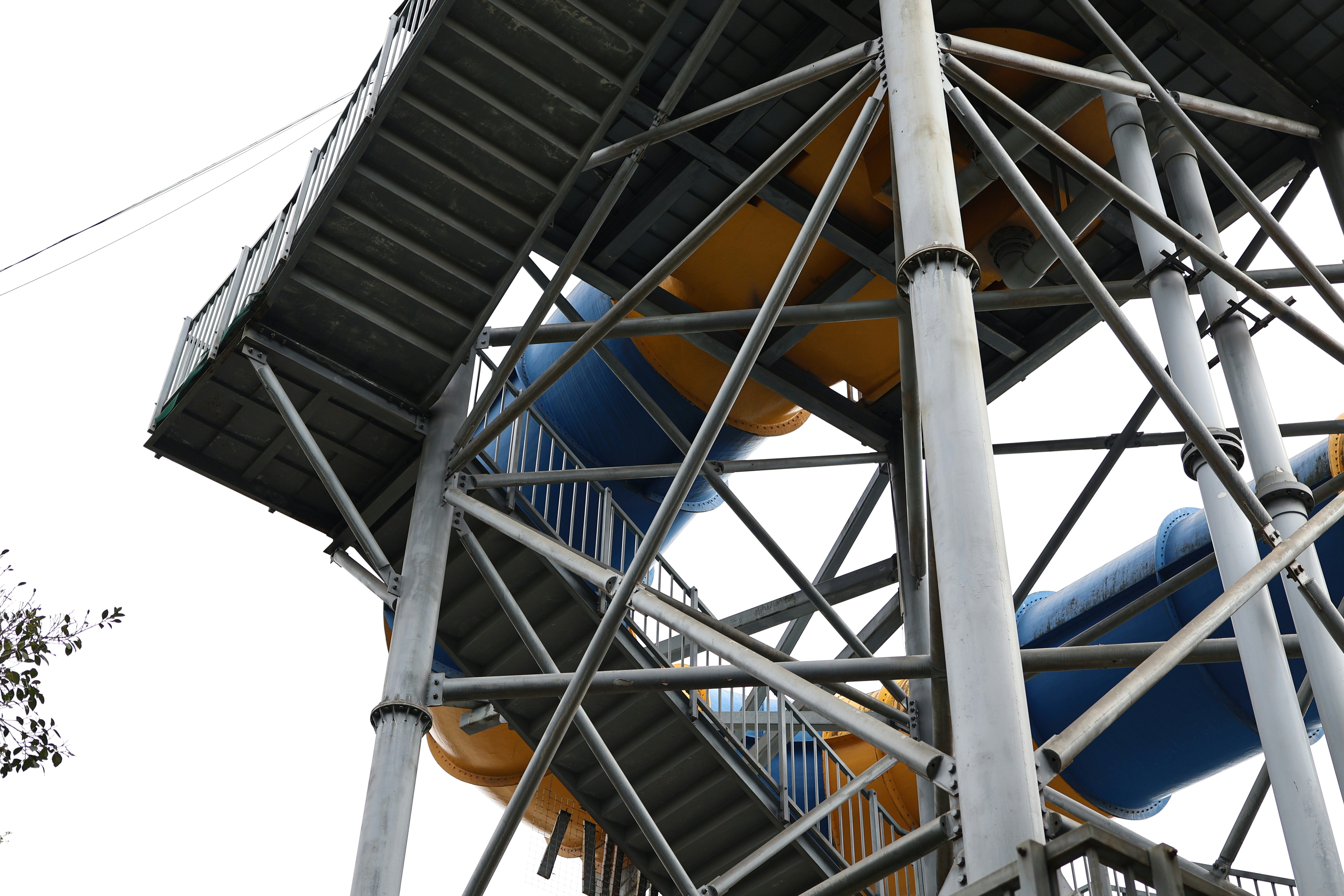 Angled play of steel and color: a structural ladderscape under the elevated slide