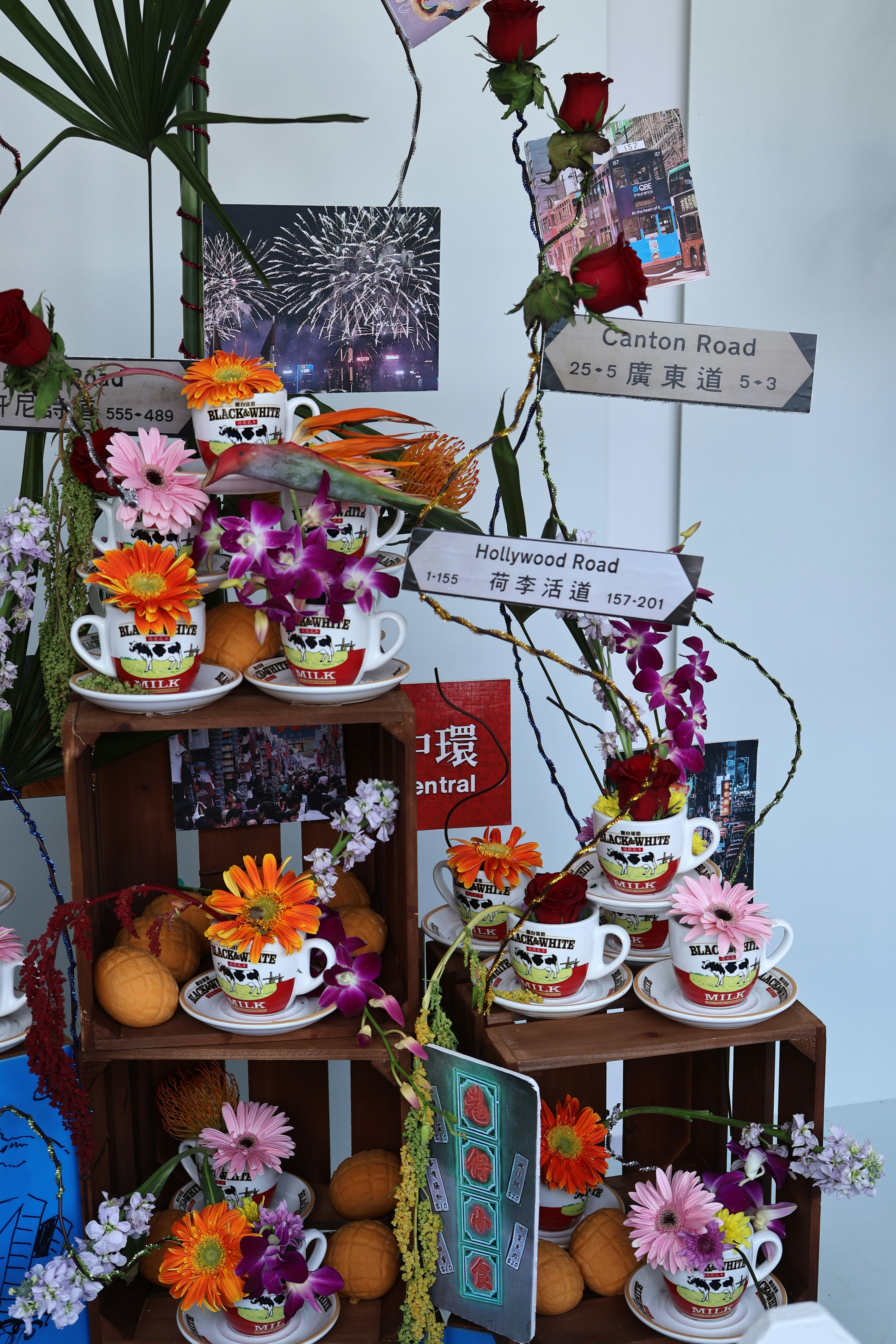 Teacups and Roses: A Kaleidoscope of Floral Arrangements on a Wooden Display