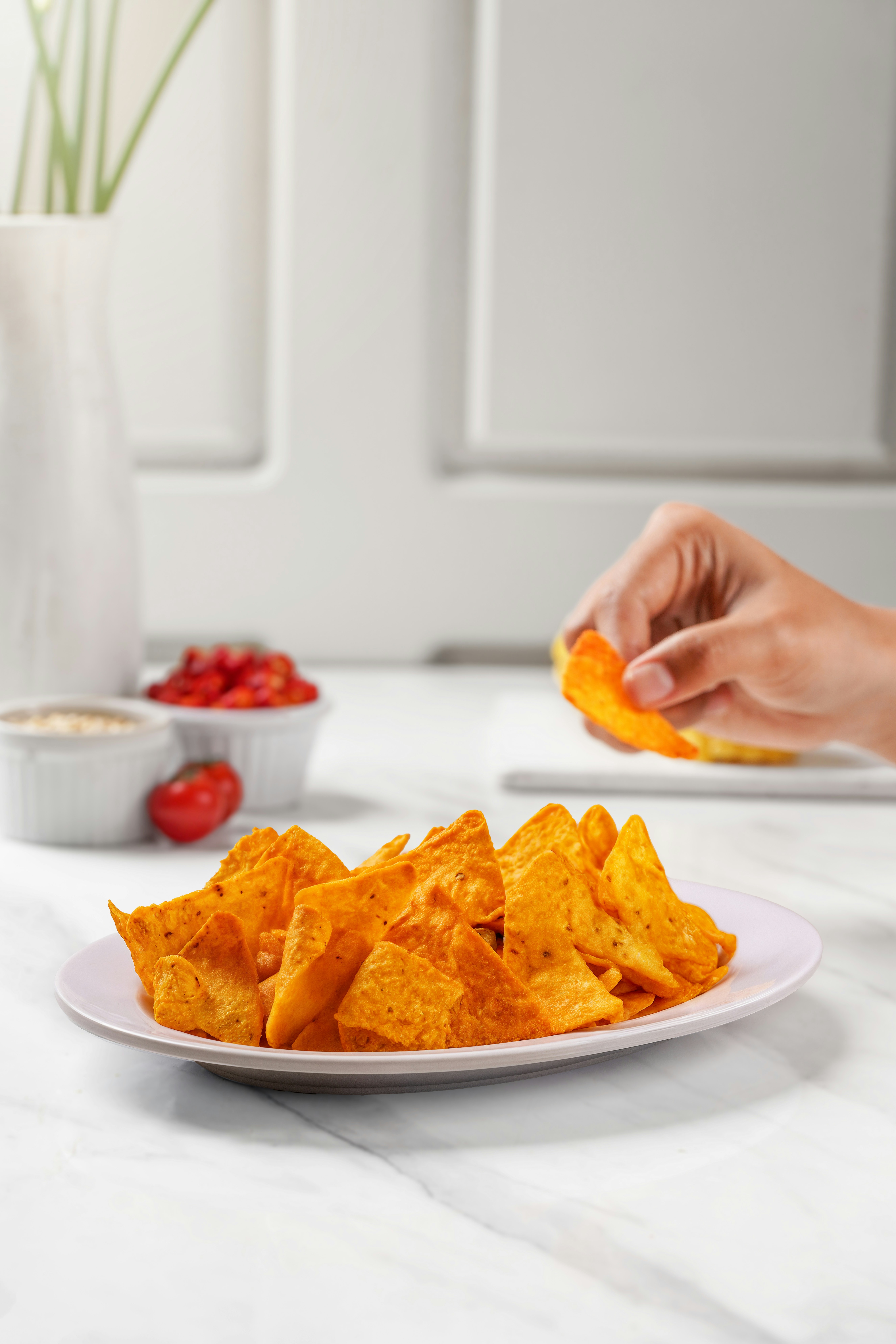 Crispy Doritos Cradle: A Hand Picks a Chip at Sunset-White Counter