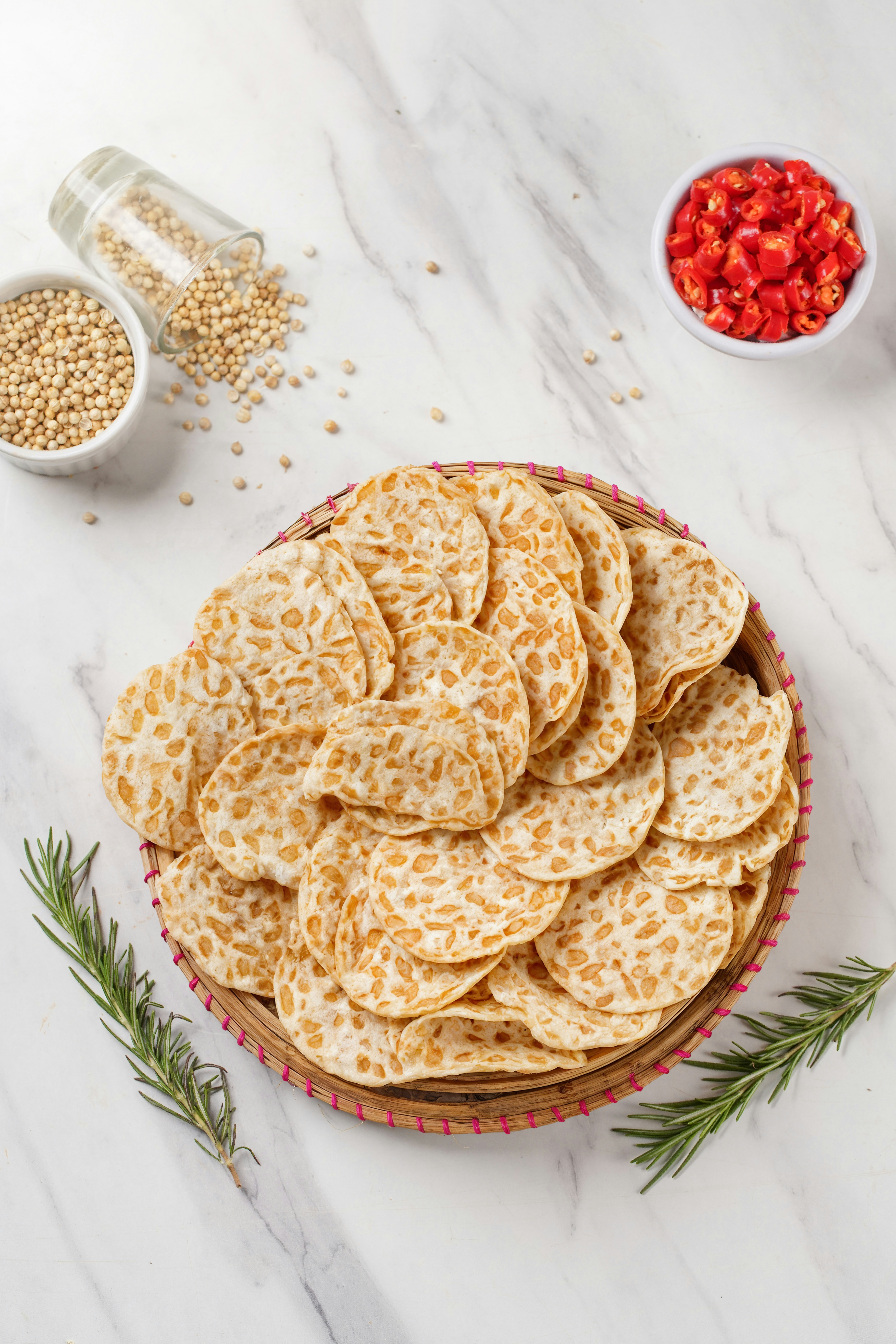 Thinly sliced tempeh arranged on a round platter with spices
