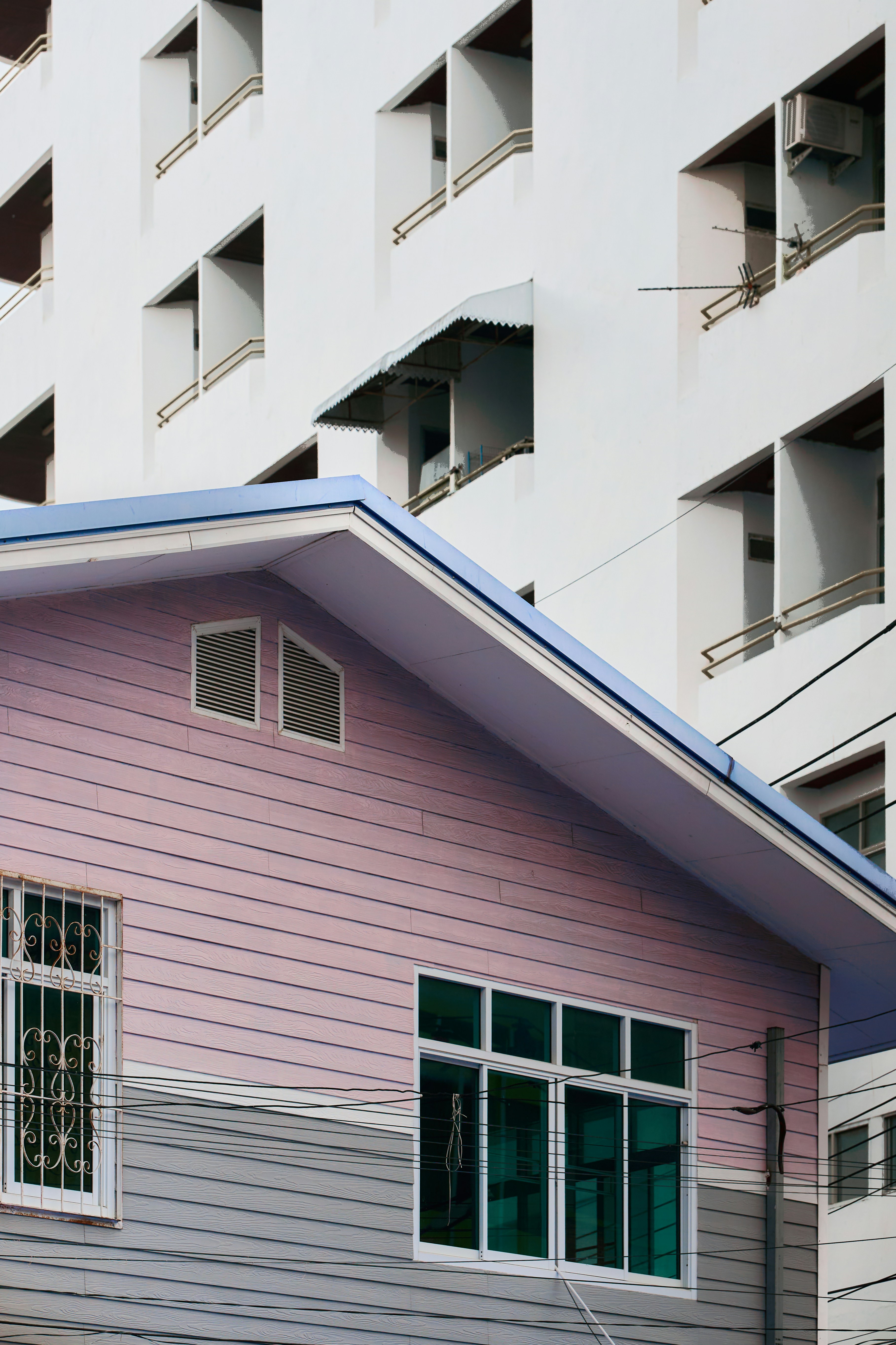 Pastel House at the Foot of a Modern Facade