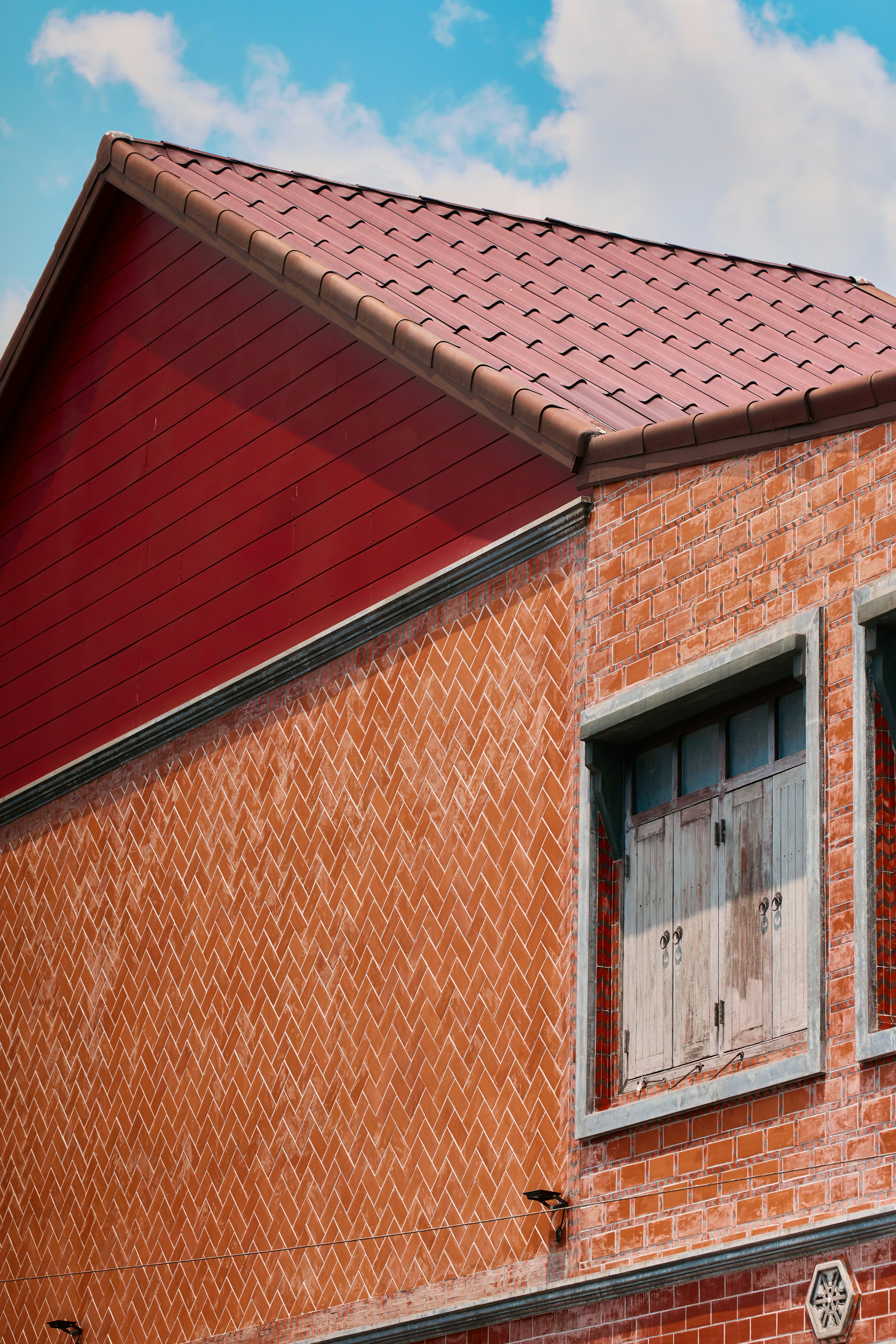 Brick Patterns and Red Roofline: A Modern Building Facade