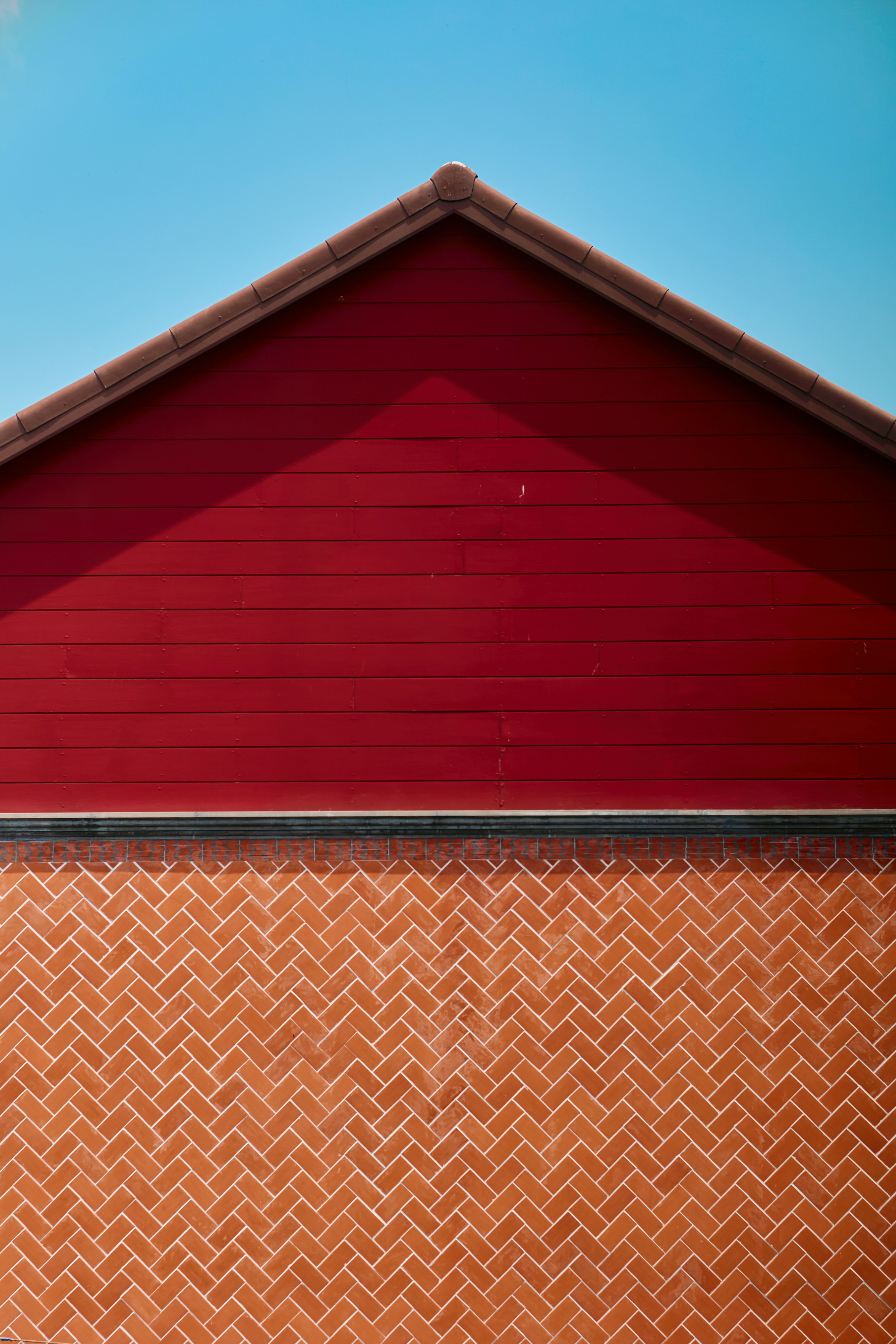 Red Gable Above the Brick Baseline