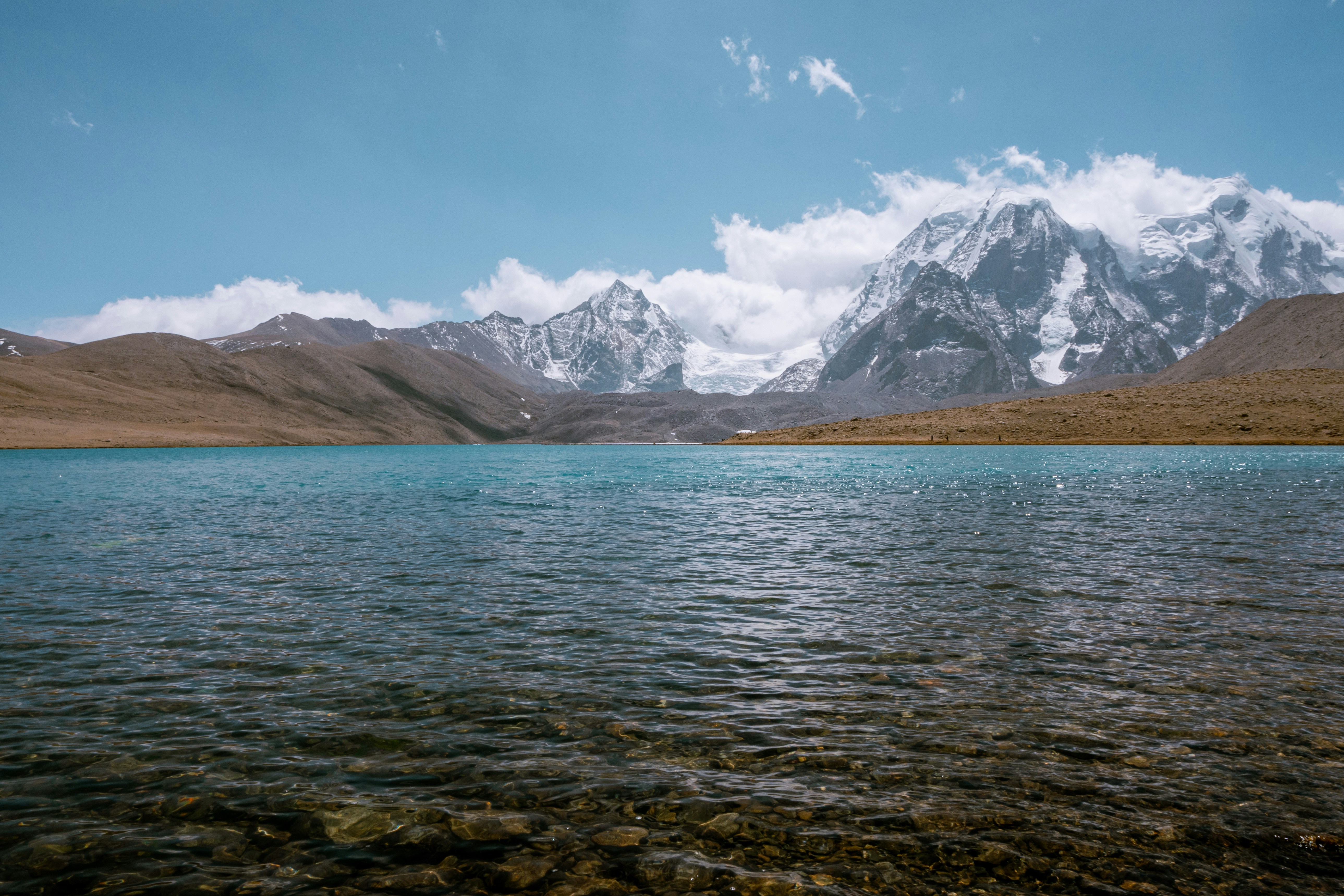 Glacial Mirror: Snow-Crowned Peaks Over a Quiet Alpine Lake