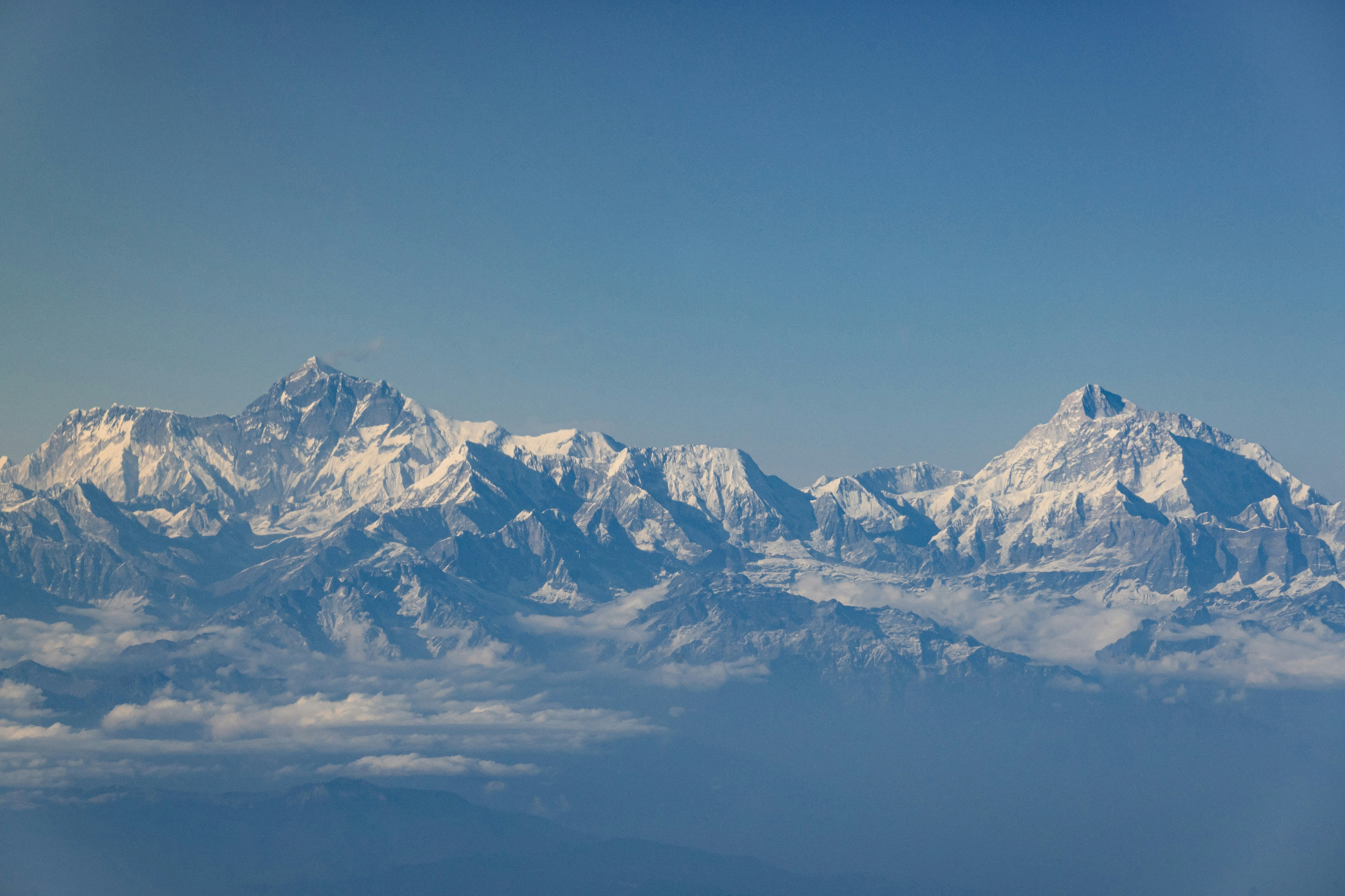 Mist-kissed Peaks: Alpine Ridge Under a Clear Blue Sky