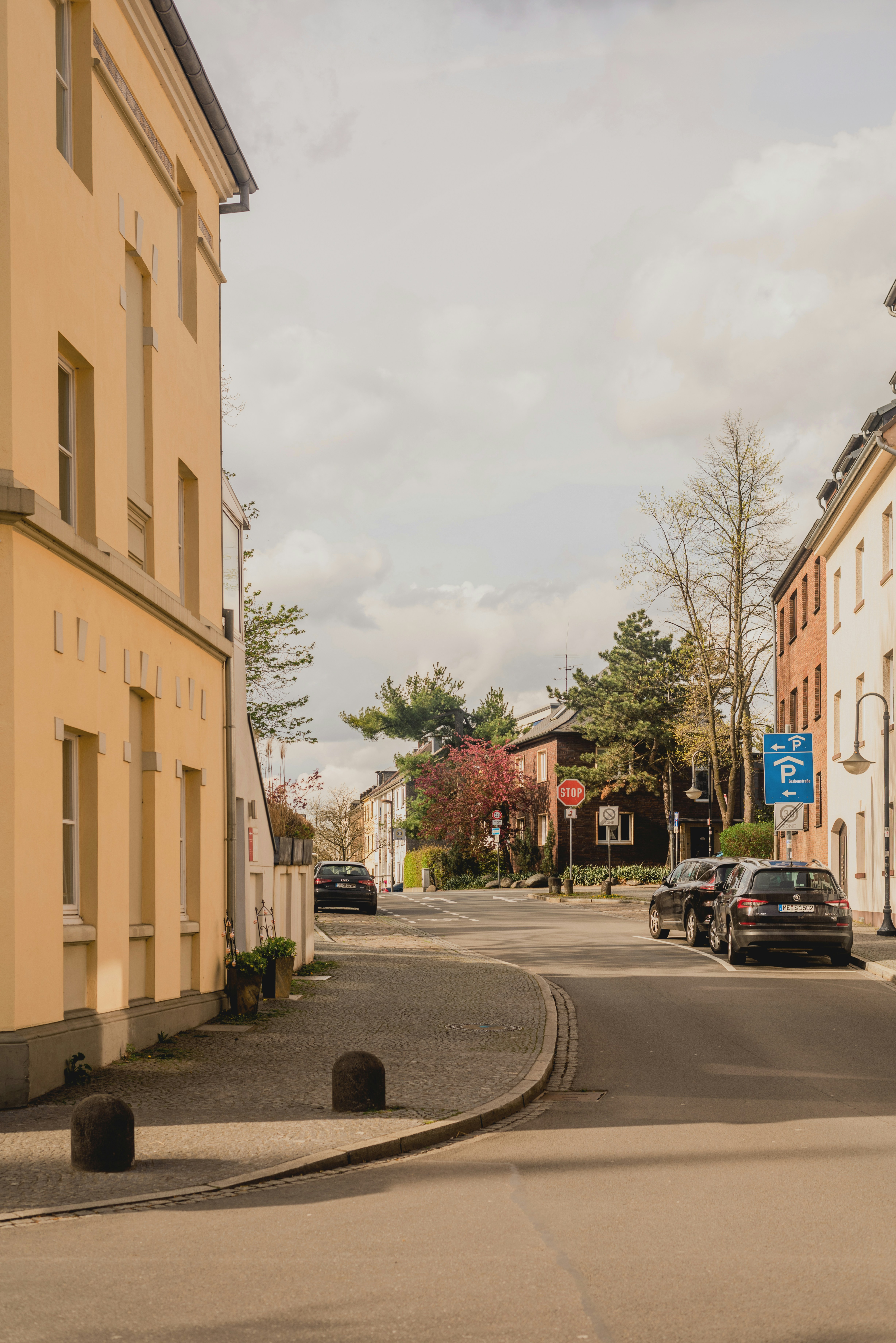 Sunlit Street with Golden Facades and Quiet Traffic