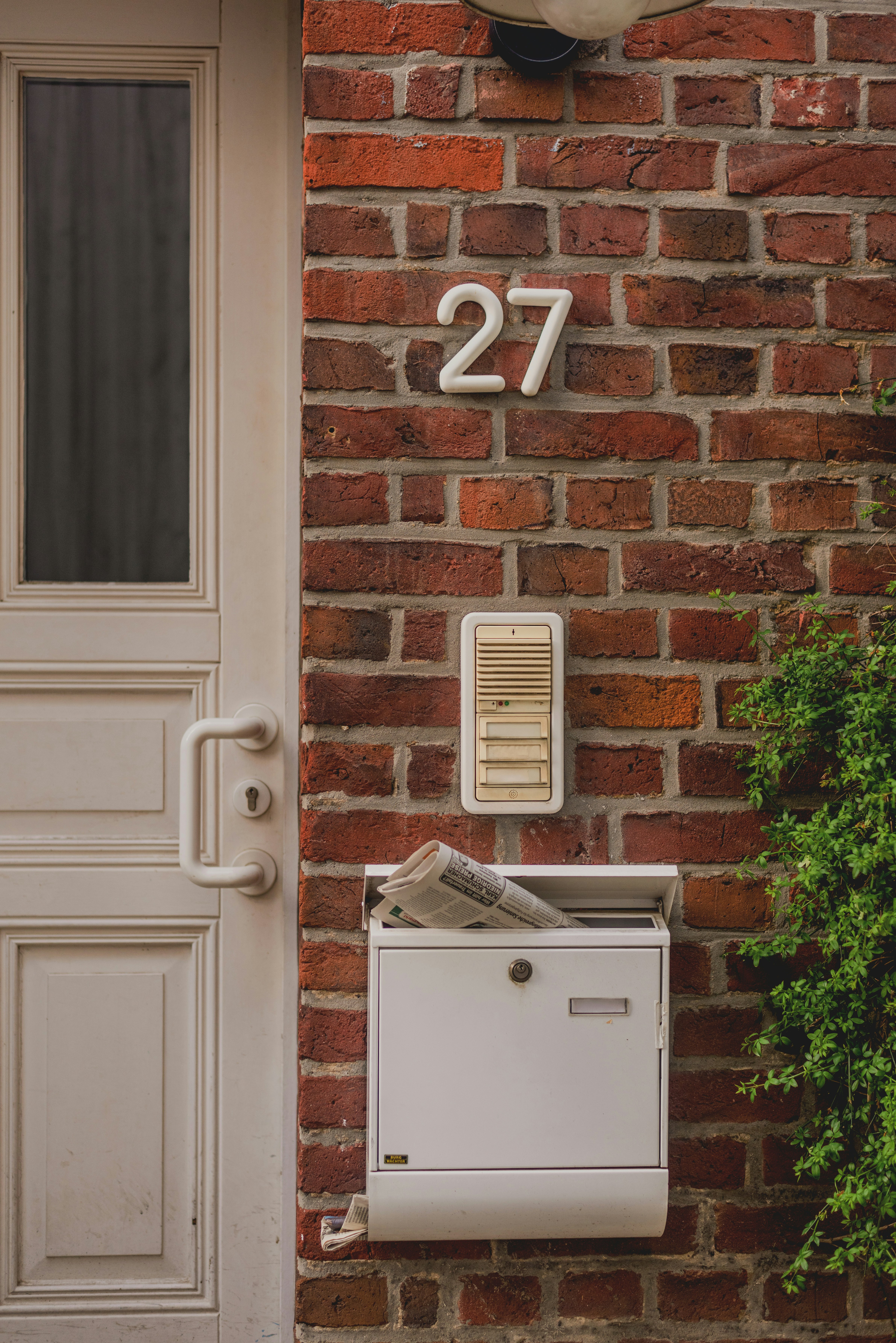 Brick House Entrance — The Door, Intercom, and Mailbox Welcome the Street
