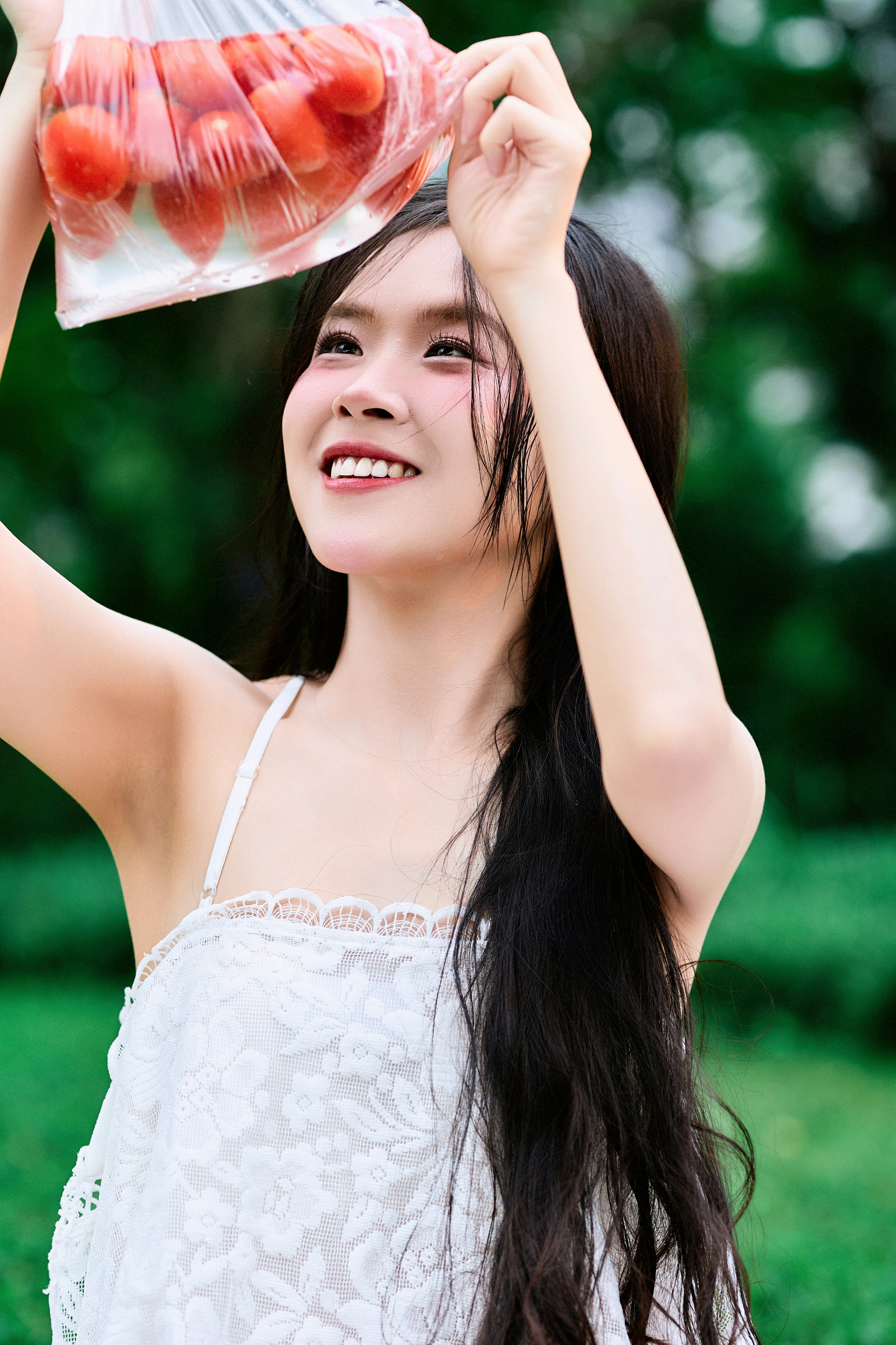 Joyful Momentum: A Woman Holds a Bag of Tomatoes Aloft