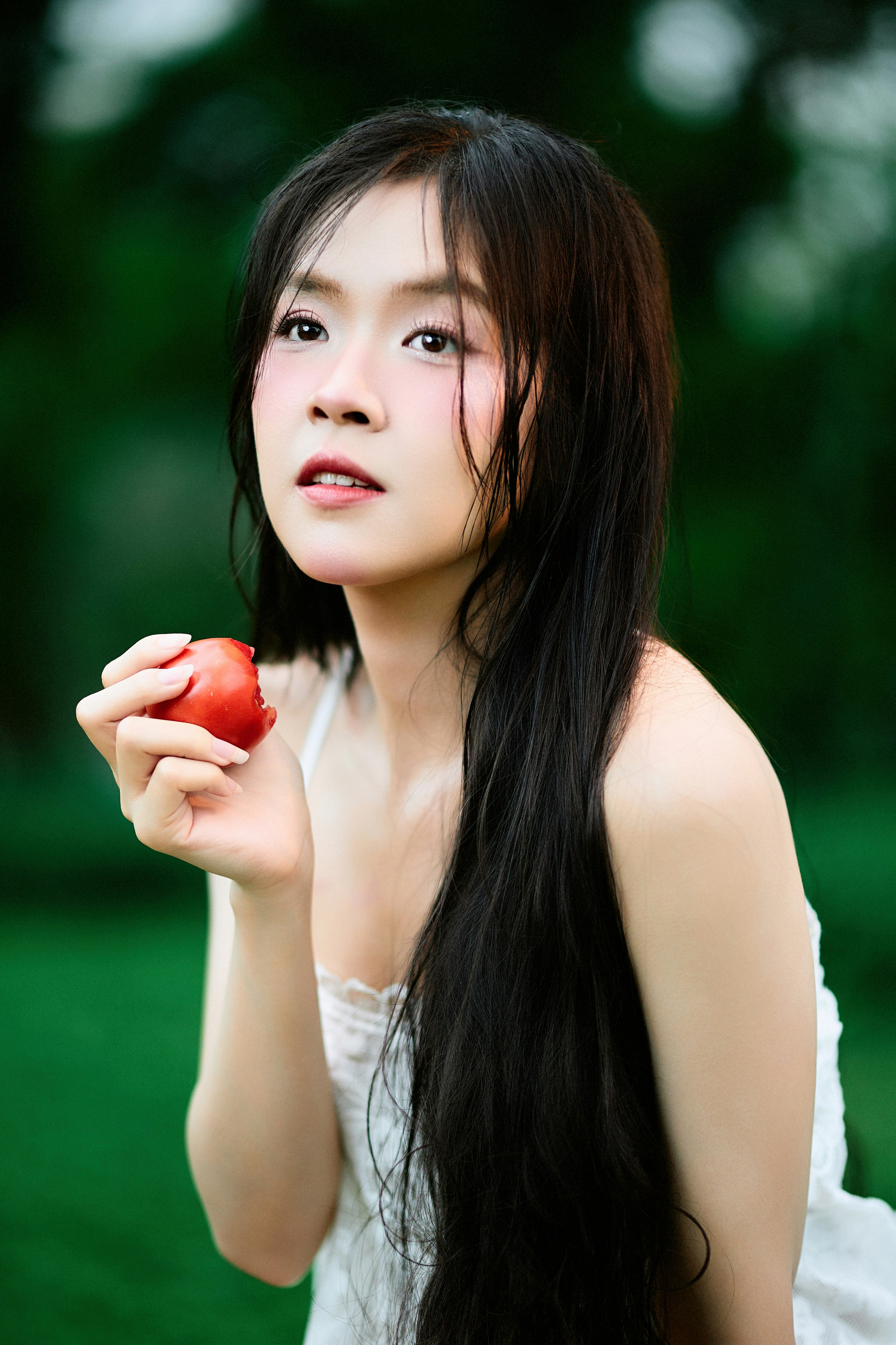 Emerald Garden Muse: A Girl in White with a Red Apple