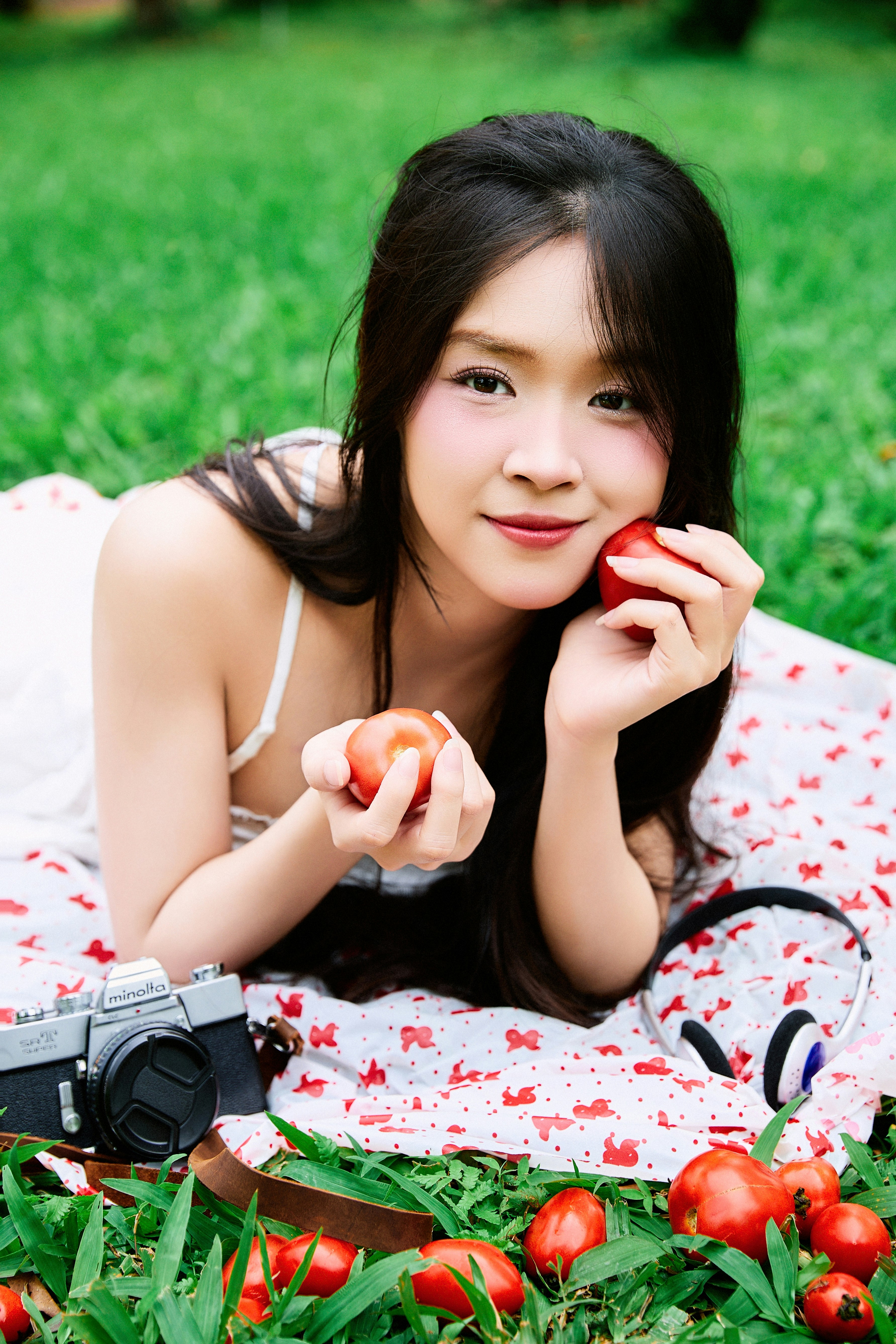 Cherry Picnic: A Languid Smile Amidst Green and Red