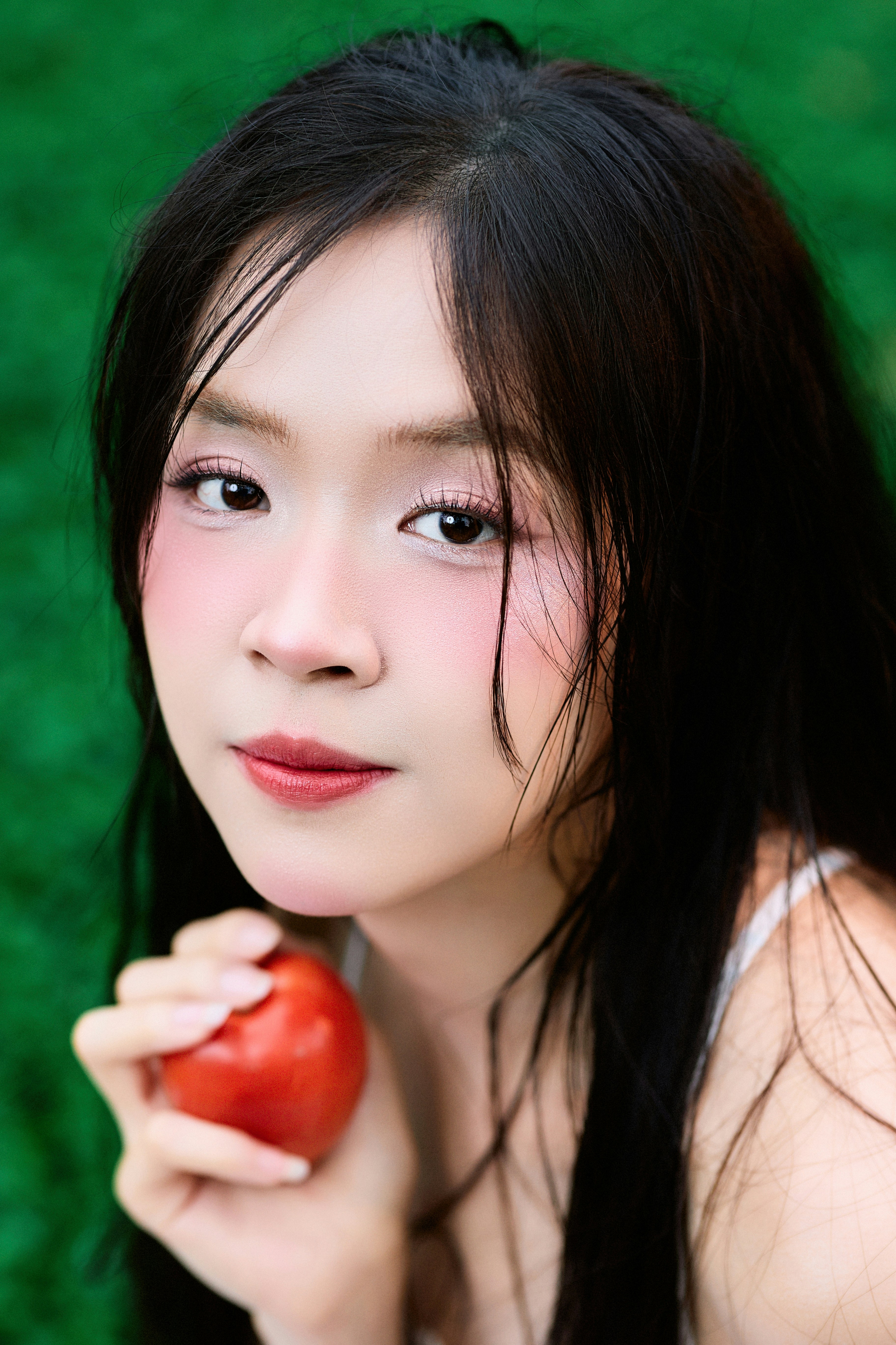 Soft Portrait of a Woman with a Juicy Red Apple in Focus