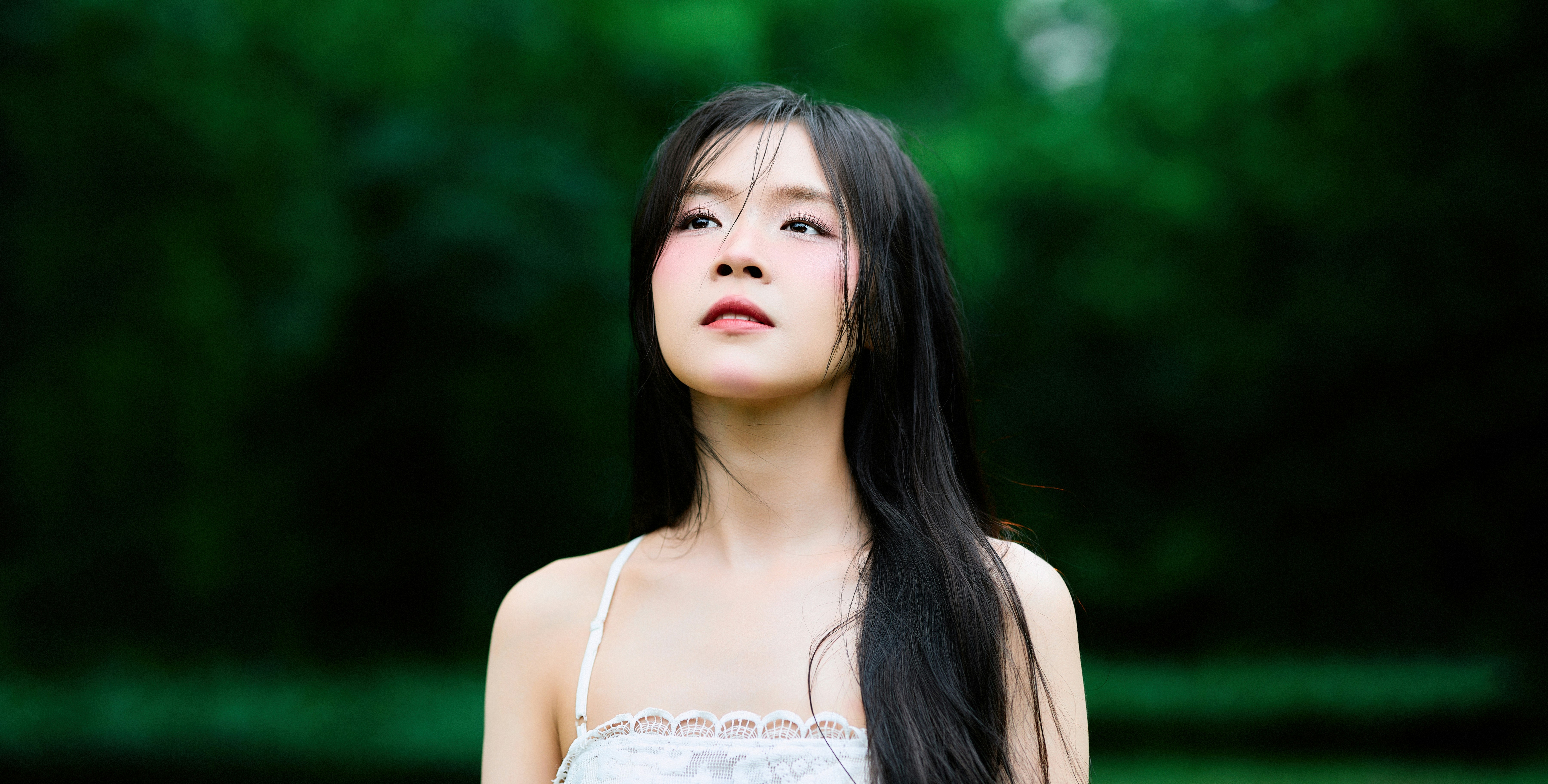 Silent Bloom: A Portrait with Soft Green Backdrop