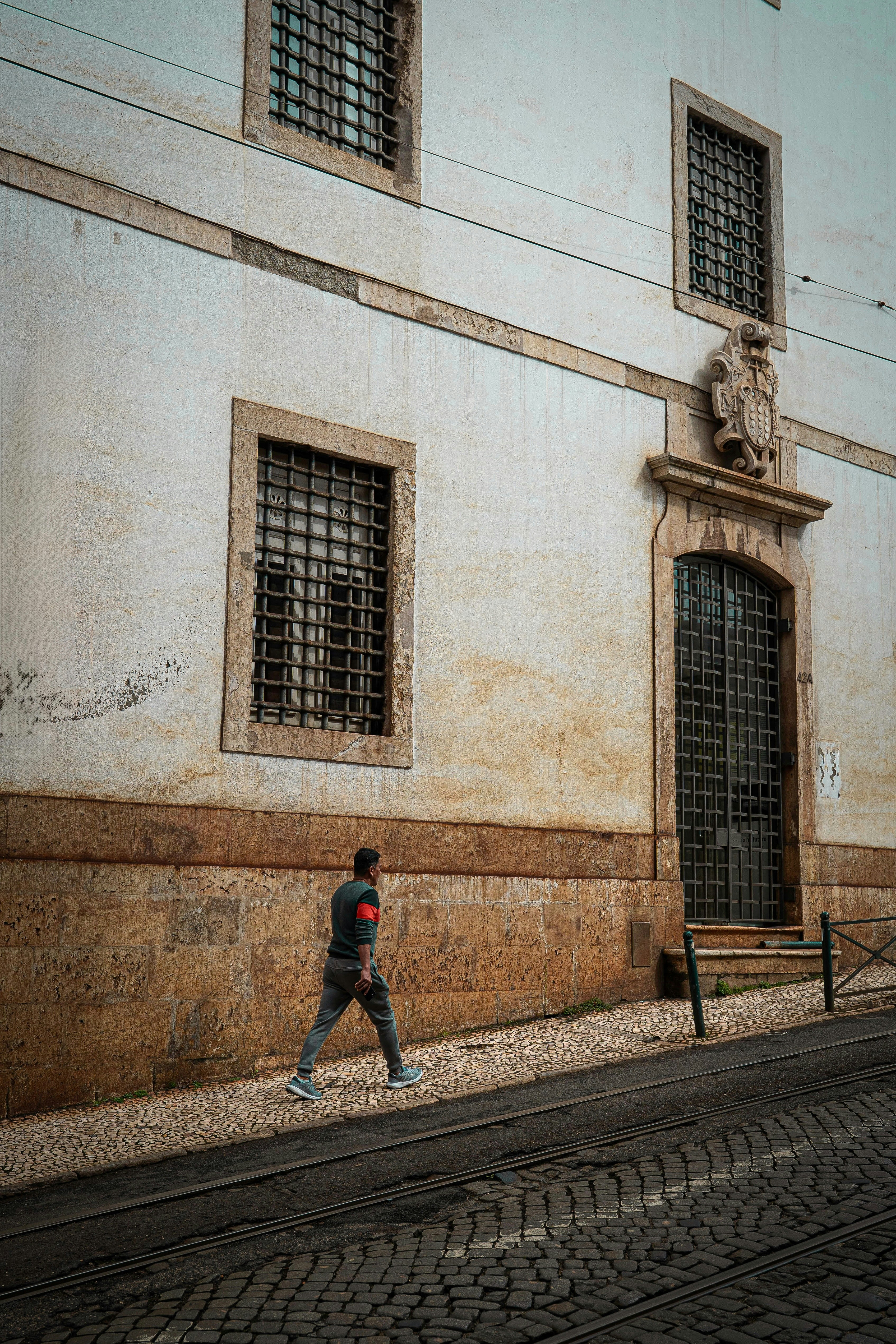 Wanderer Below a Historic Facade