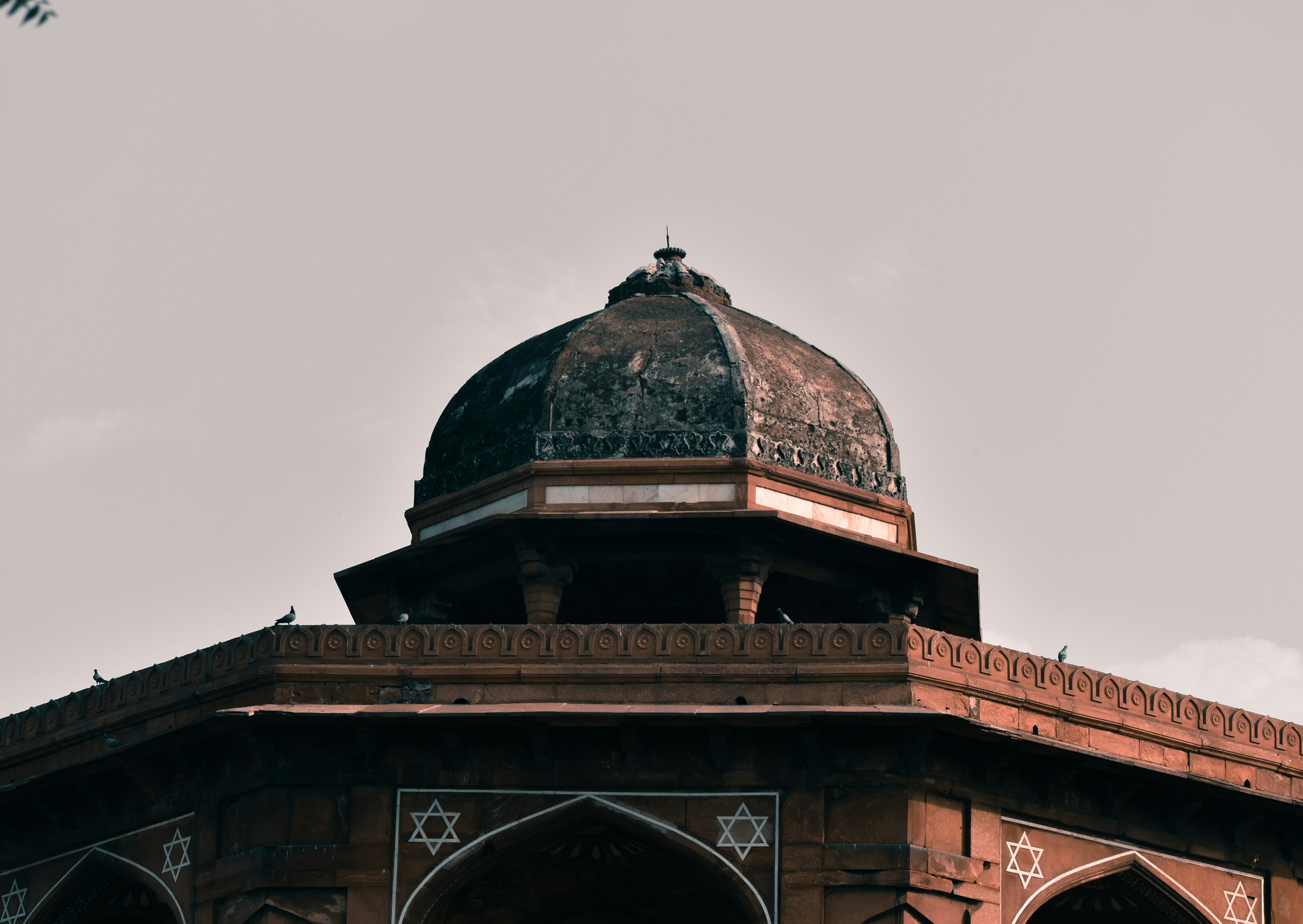 Dome Sentinel: Carved Summit Over a Historic Facade