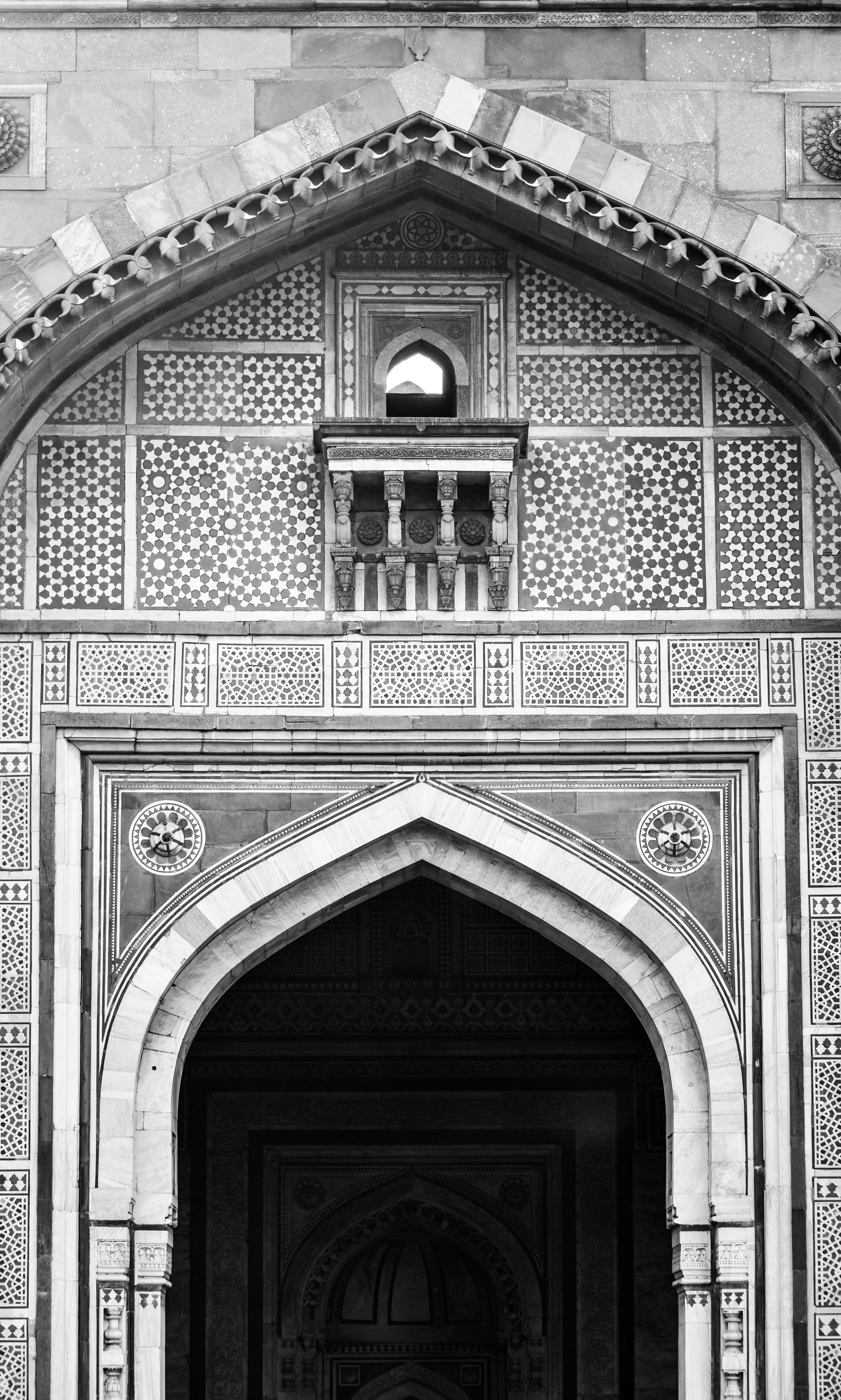 Archway of Intricate Geometric Tiles: A Black-and-White Facade
