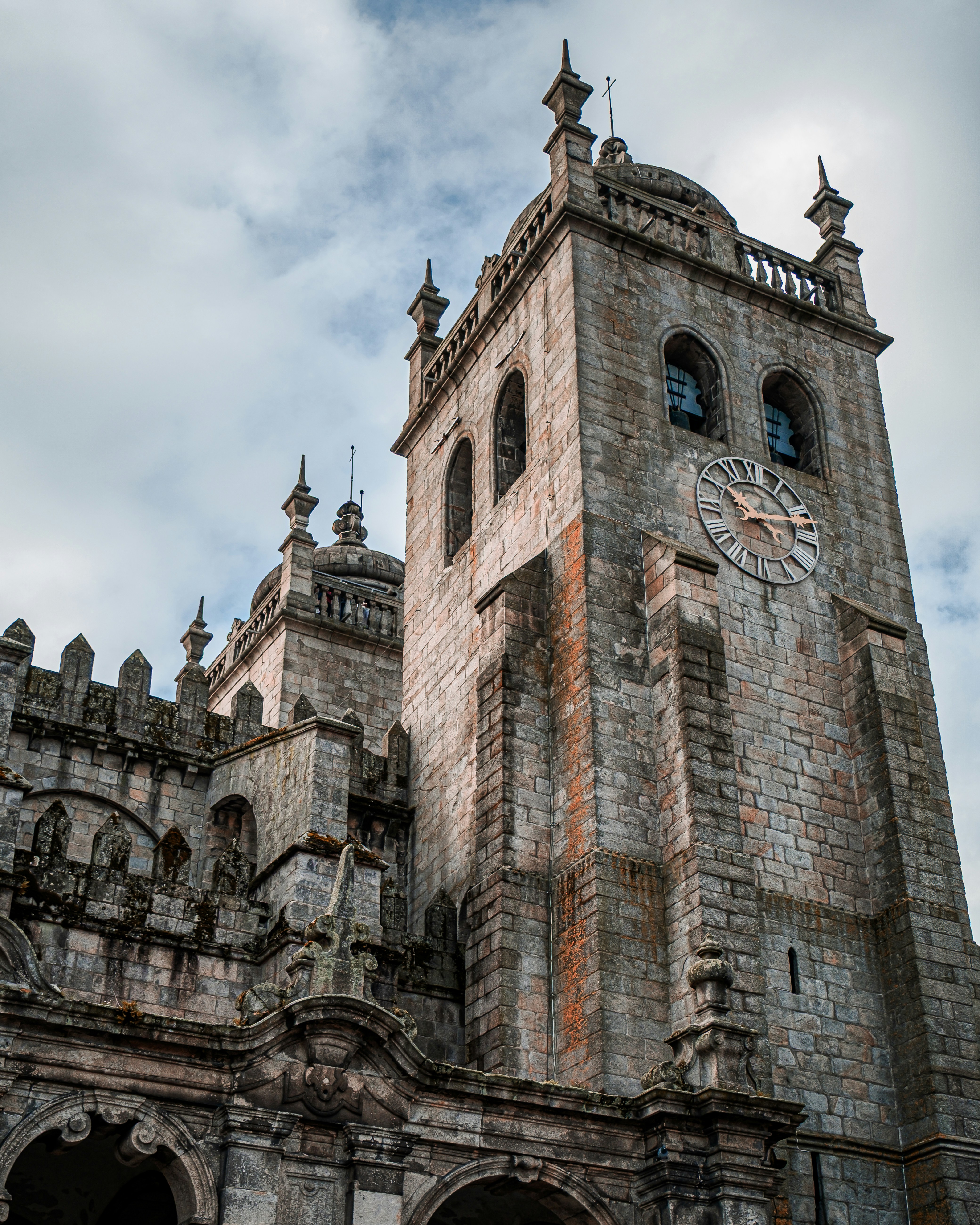 Stone Clocktower Rising Above Gothic Turrets