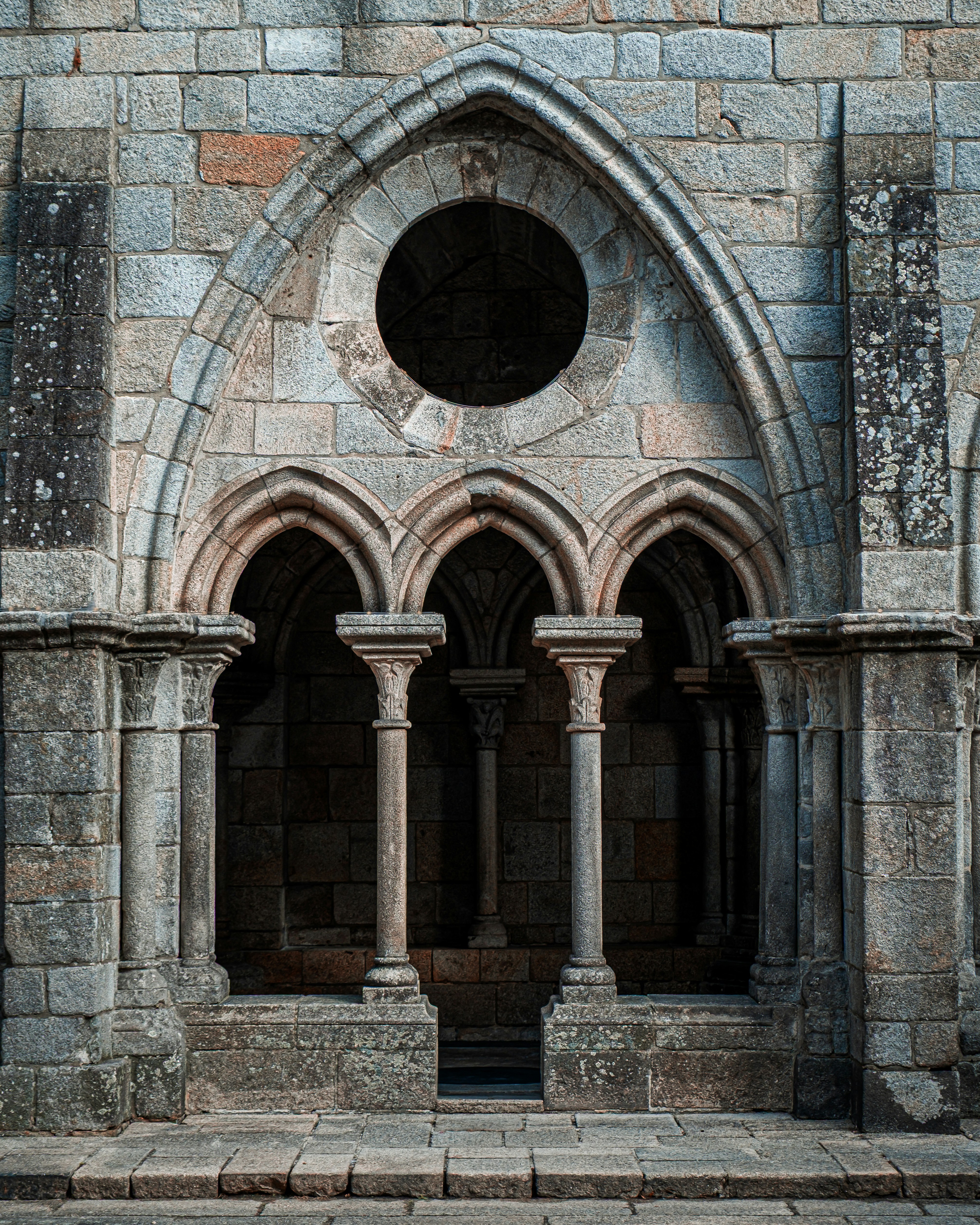 Stone Archway with Circular Window Framing in Gothic Rubble