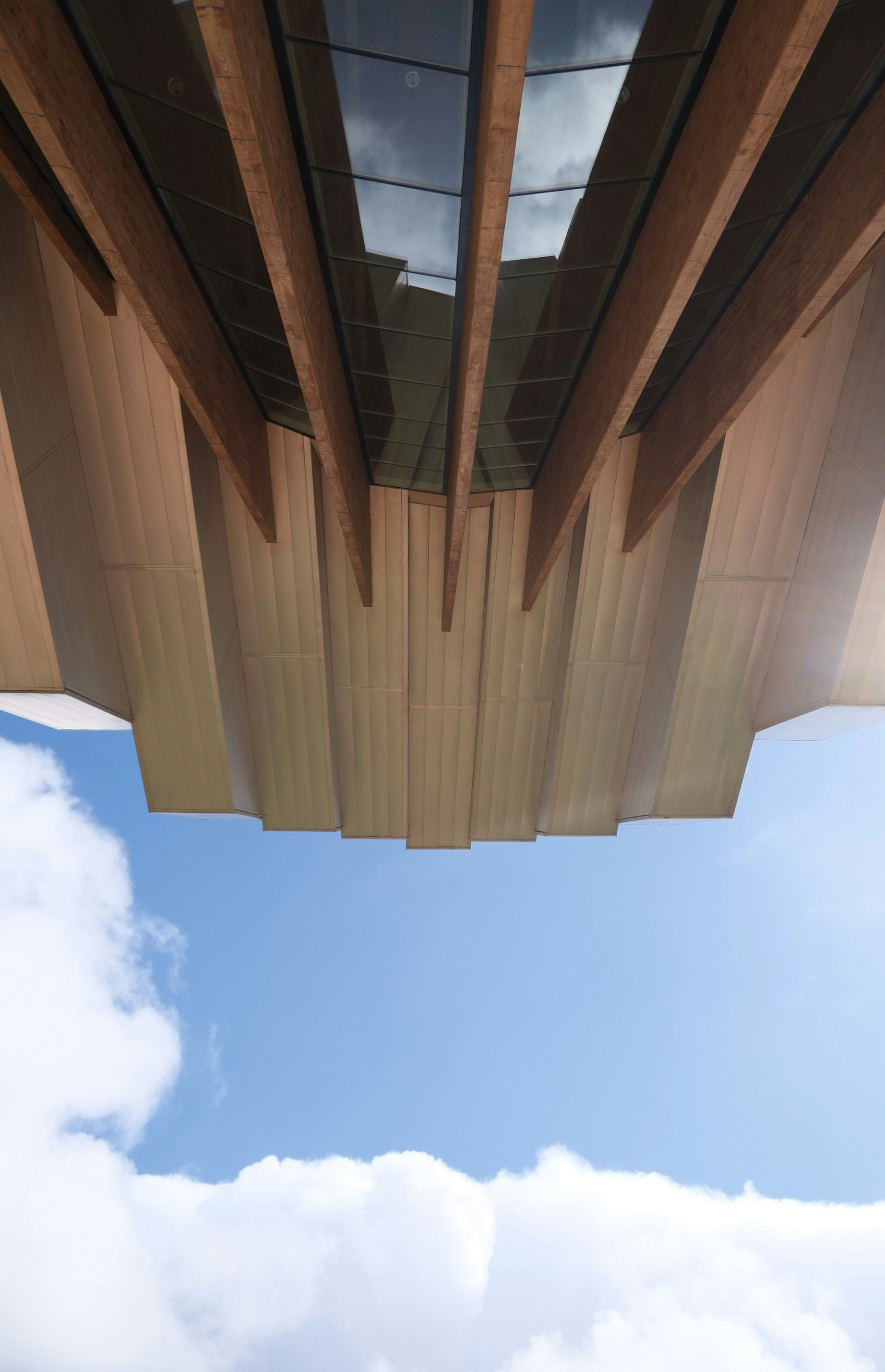 Architectural vertigo: upturned copper ribs against a sapphire sky