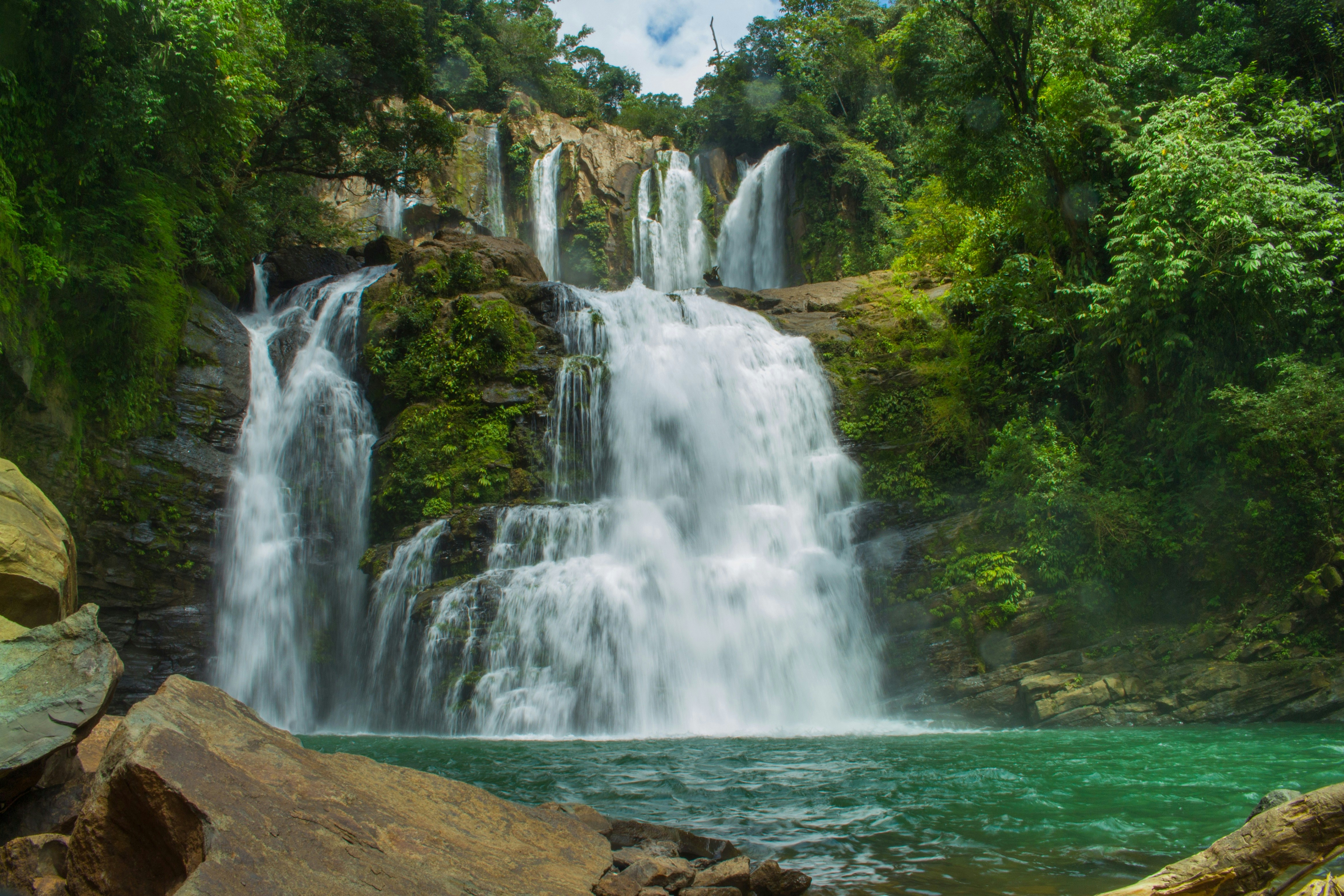 Verdant Cascade: Green Pooling Waterfall