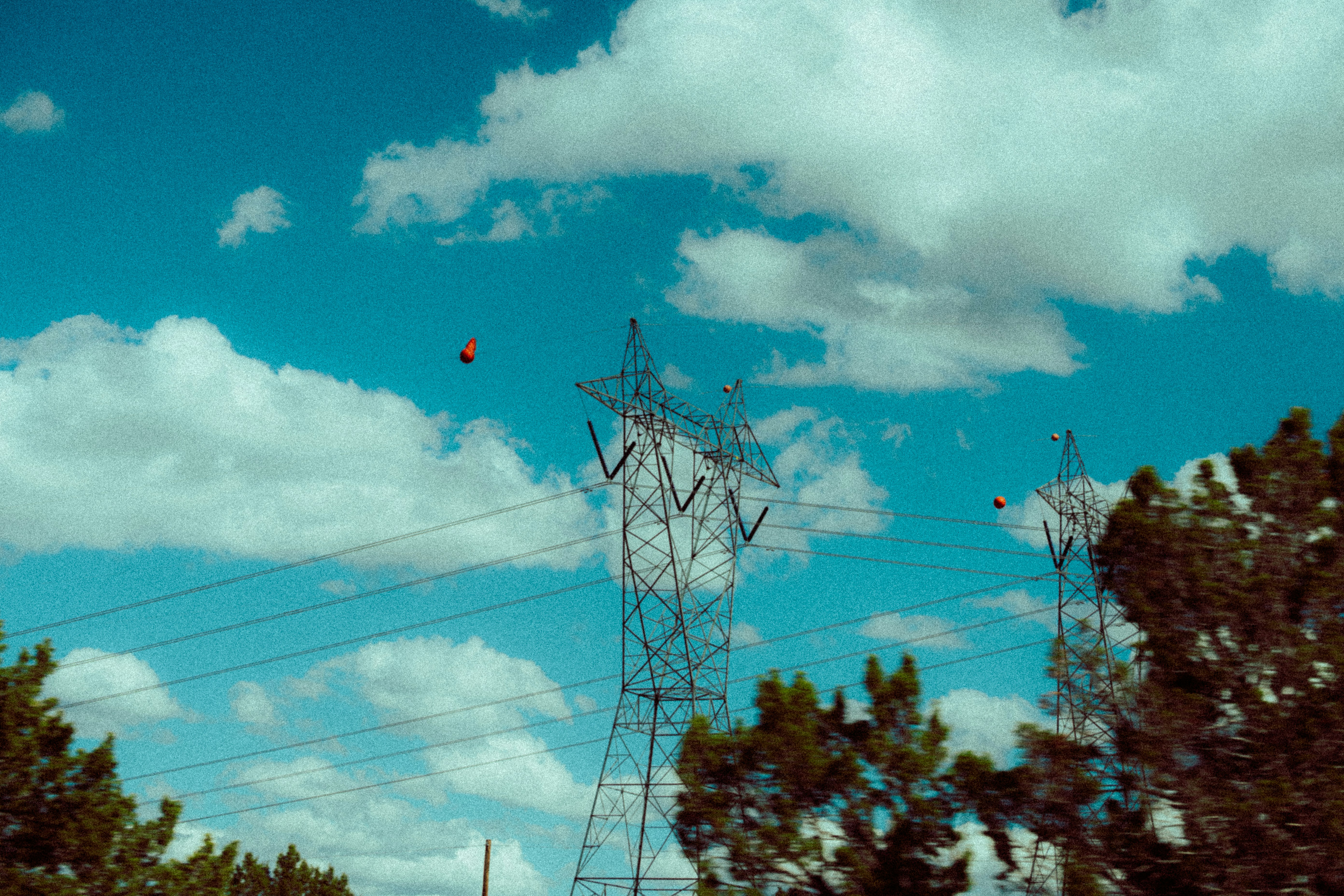 Power Lines and Pylons Against a Sky of Clouds