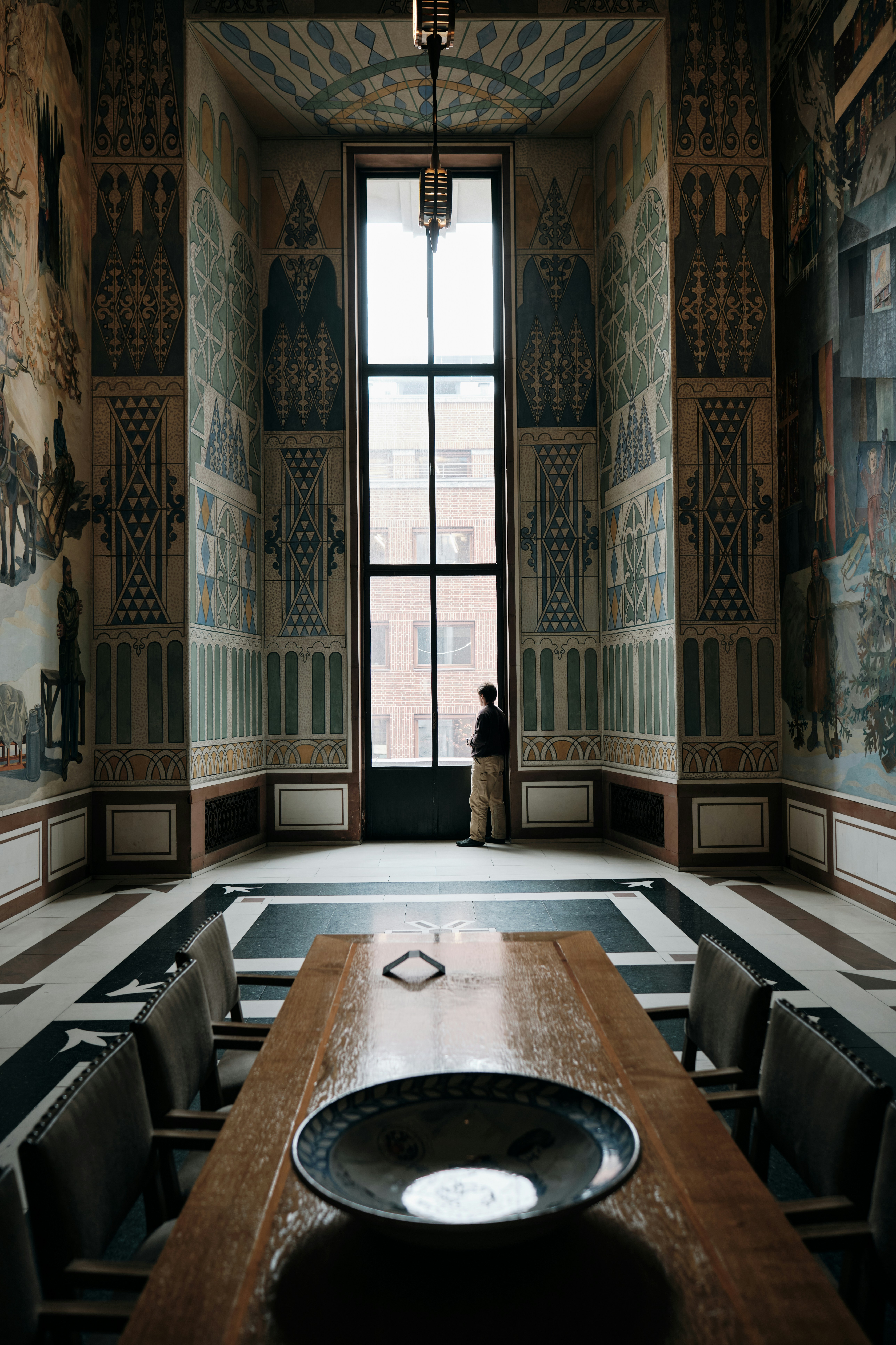 Silent Witness: A Quiet Figure at the Window of a Painted Hall