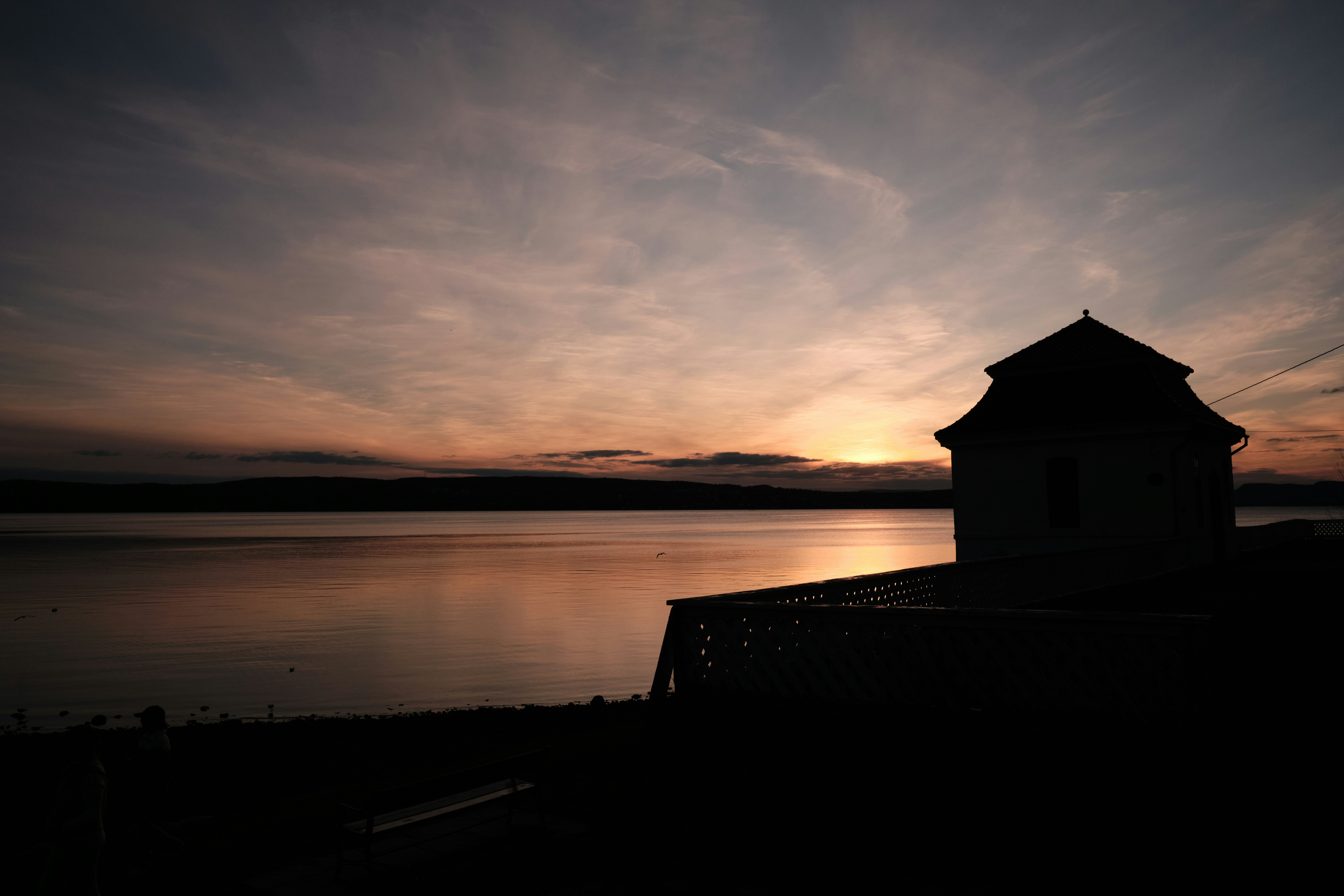 Silhouette at Dusk: A Quiet House by the Waterfront