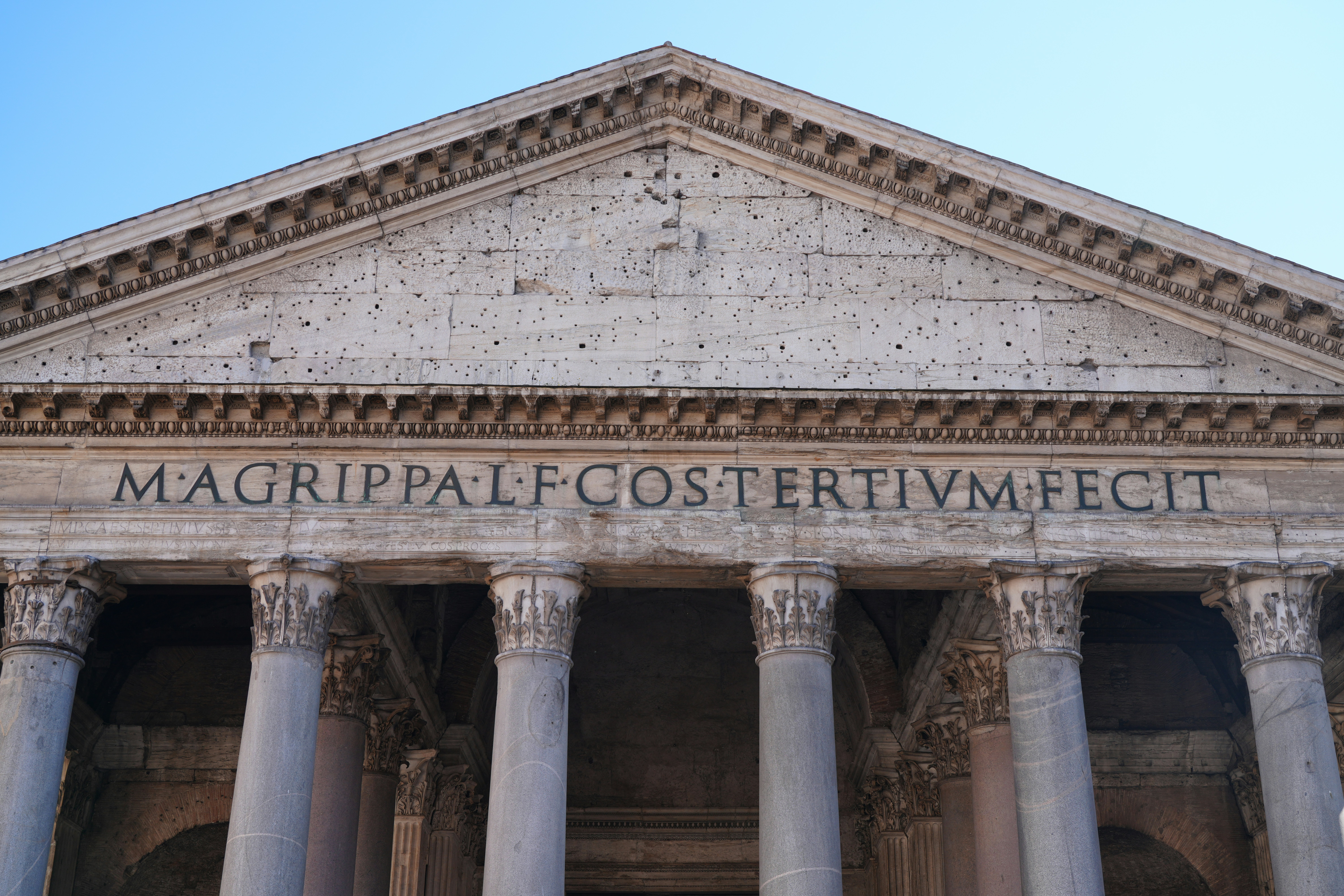 Stone Facade of the Temple of Pax: Columns and Inscription Under a Clear Sky