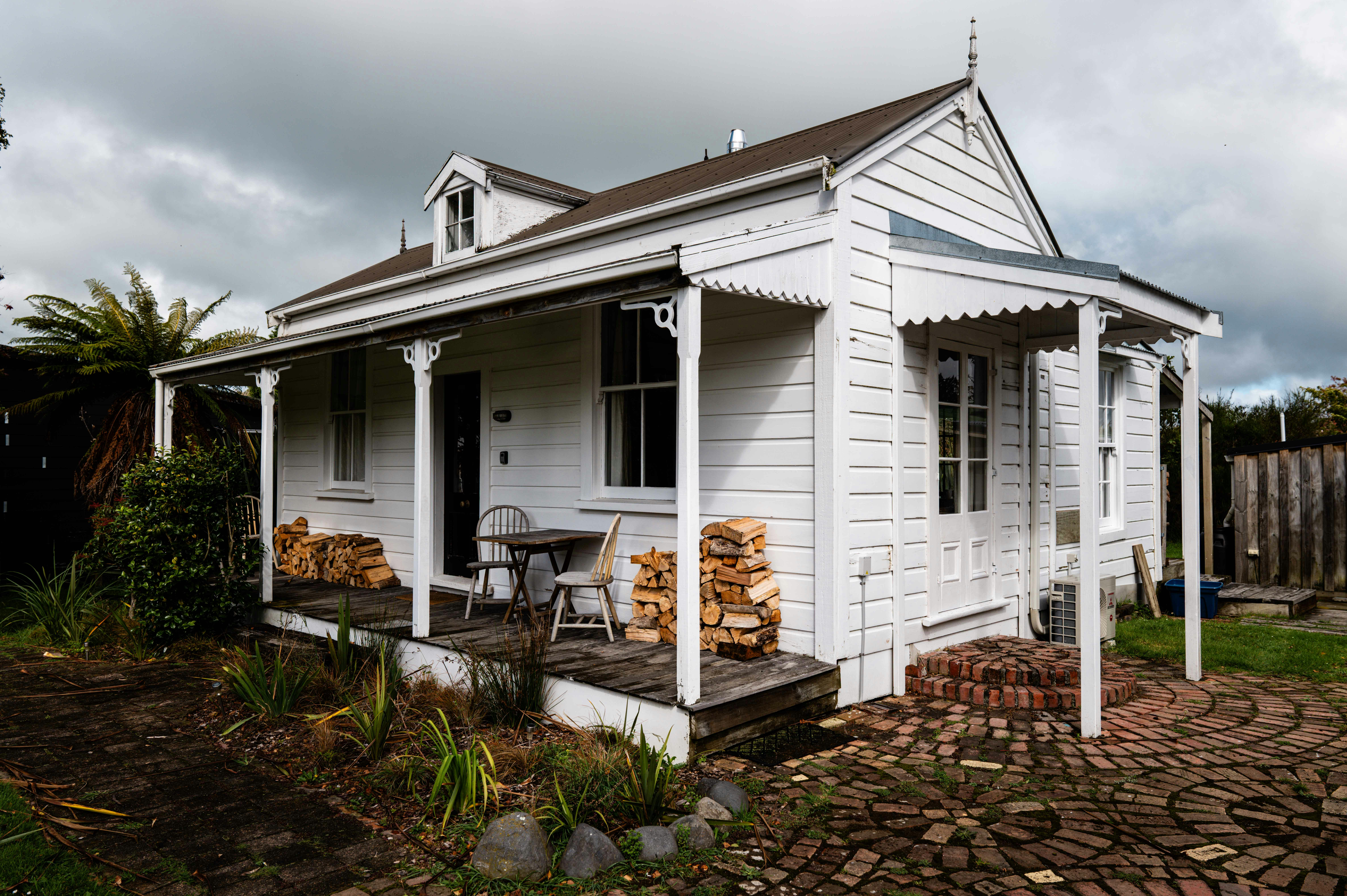 Sunlit Cottage Porch with Firewood Accents