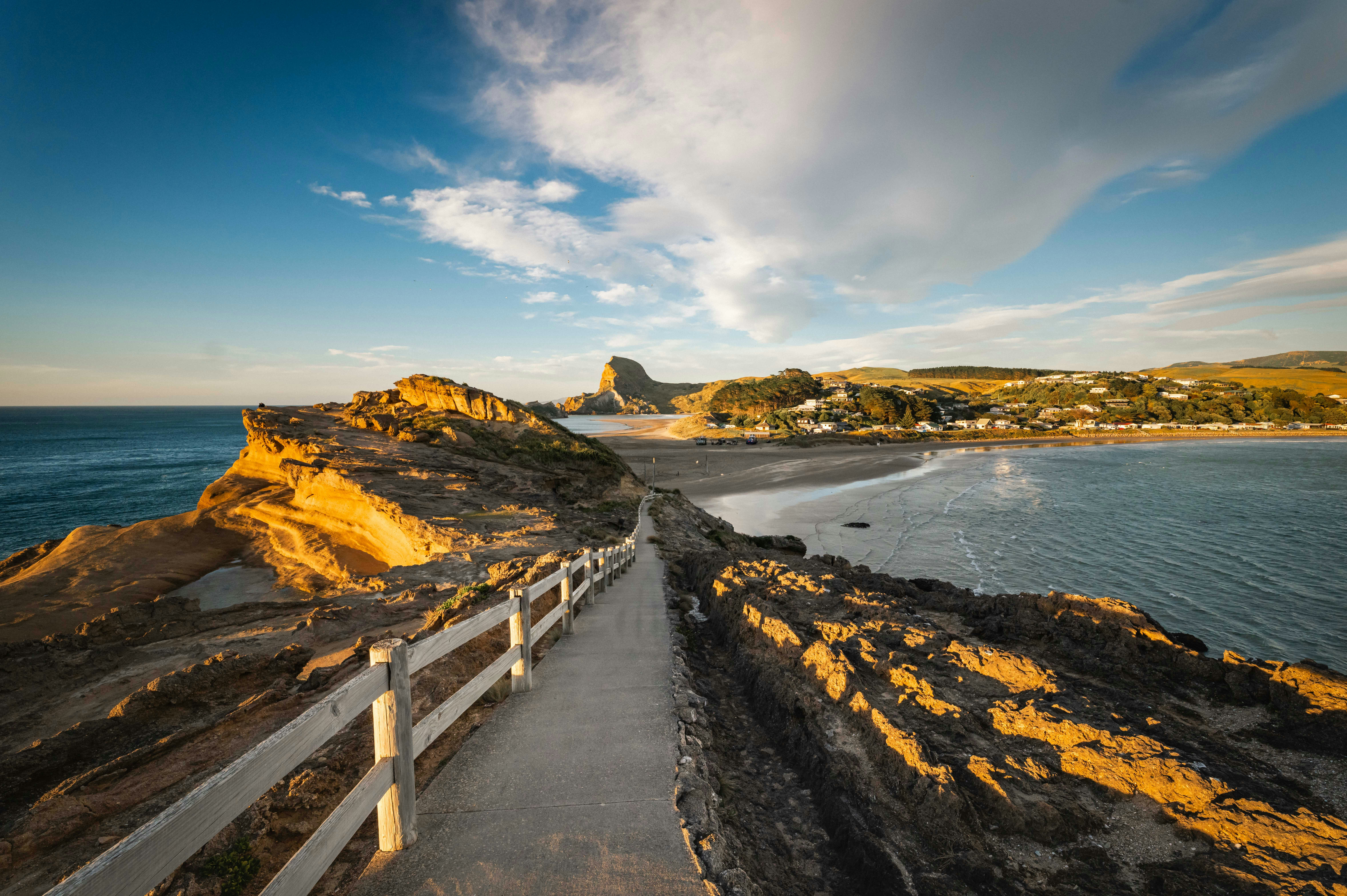 Sunlit Promenade Along Lava Coastline at Dusk