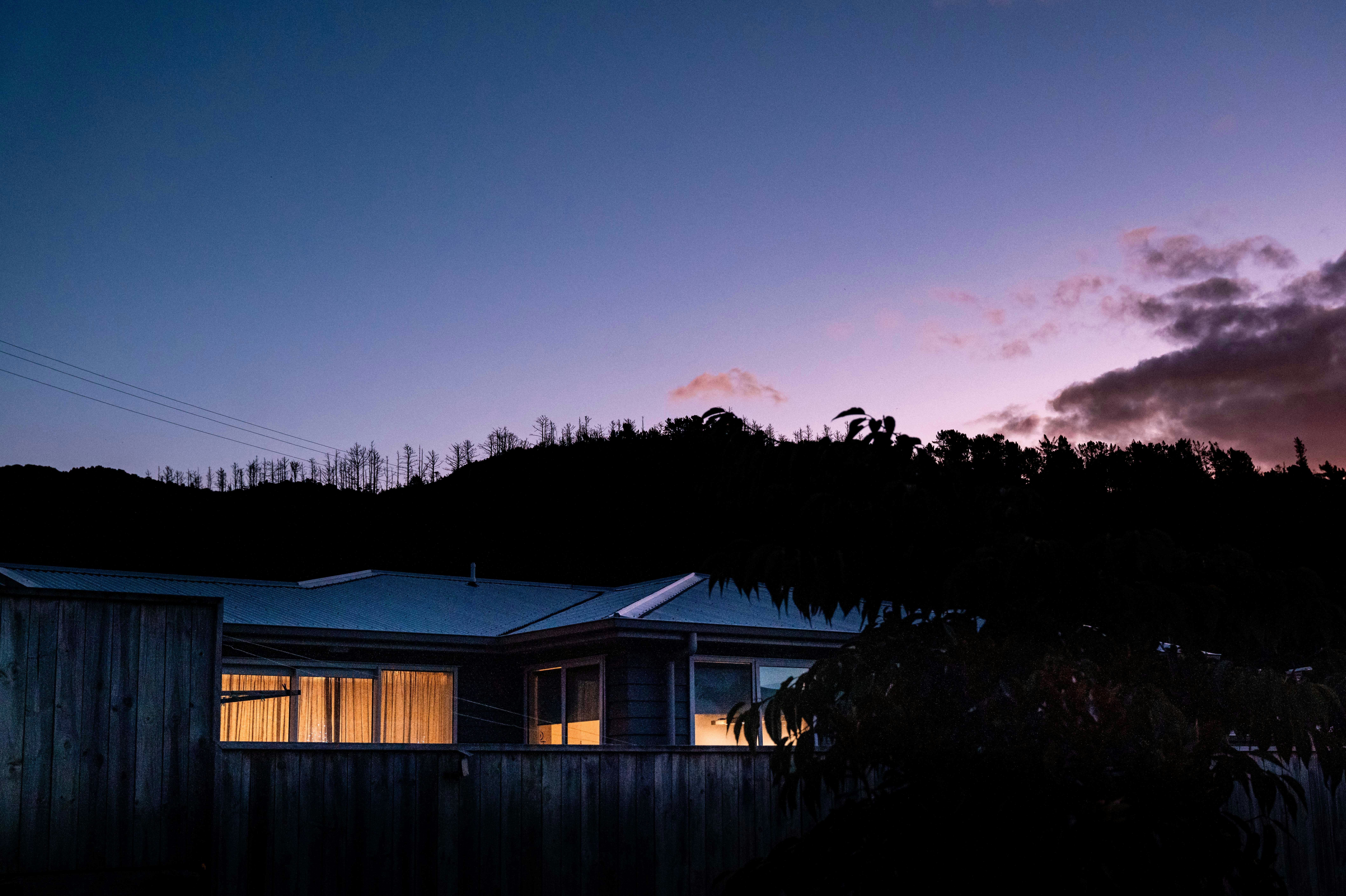 Dusk at the Quiet Studio: Warm Light Beneath a Dark Skyline