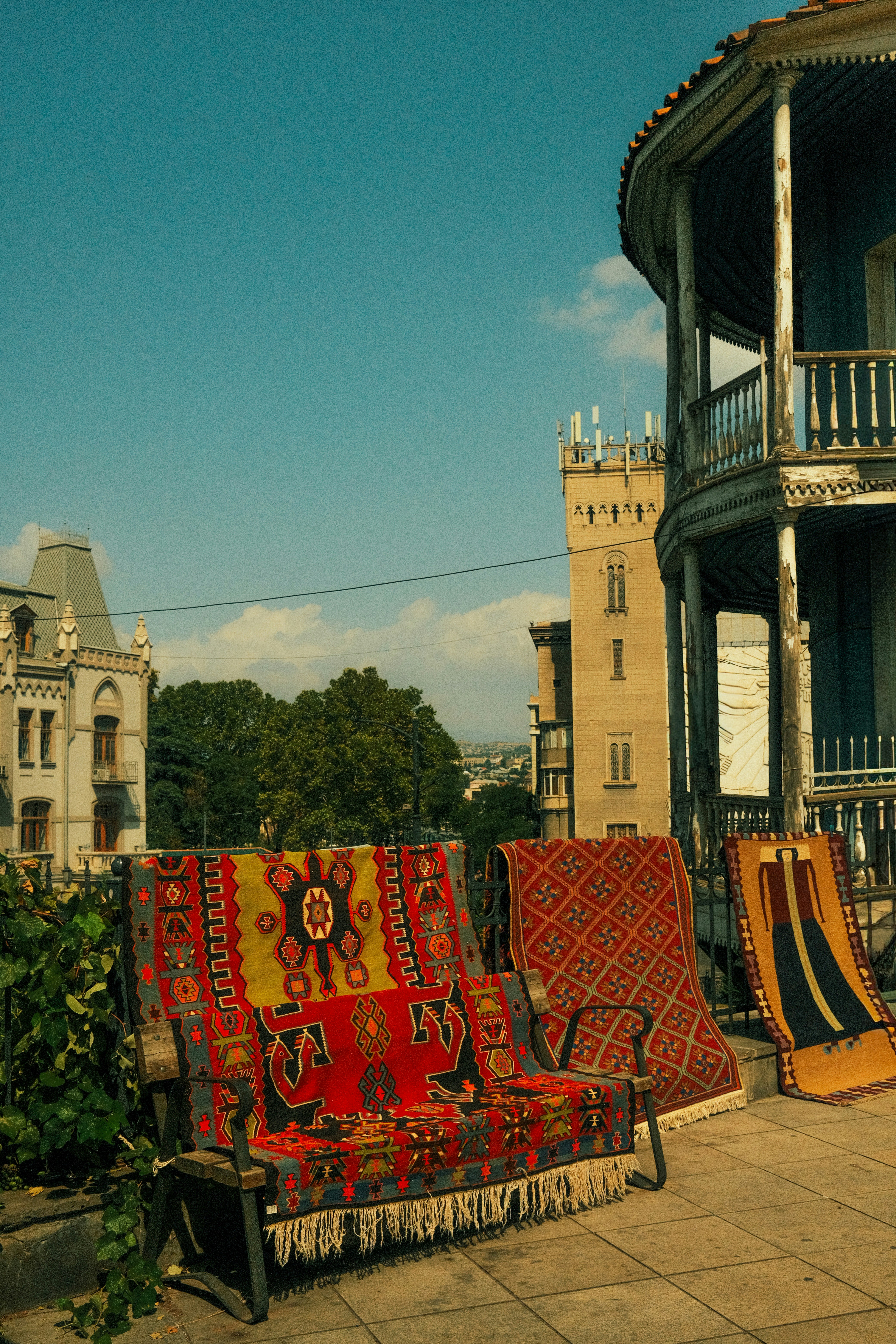 Rugged Veranda Vista: chairs, architecture, and distant cityscape