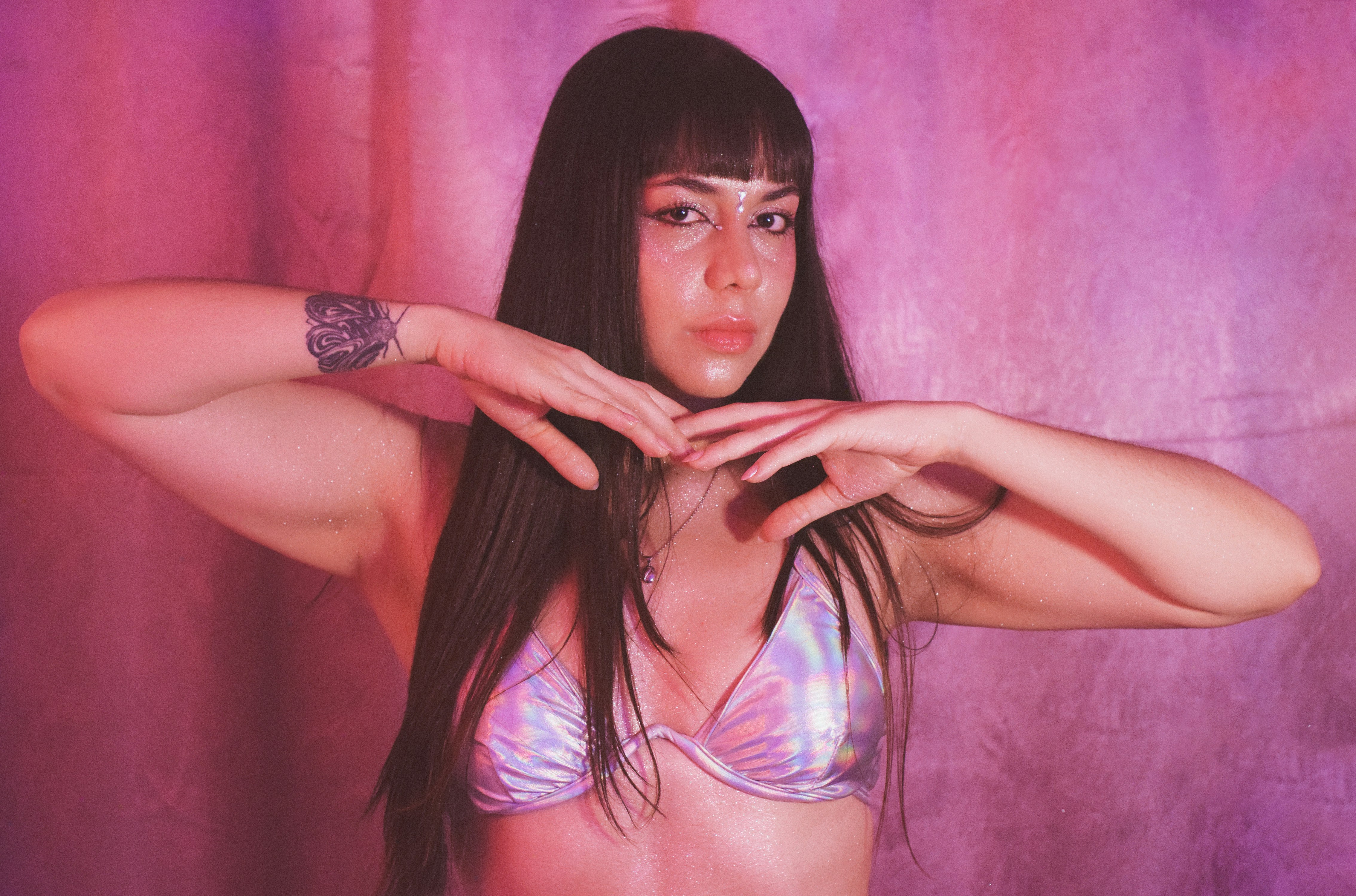 Neon-lit Pose: A Tank Top Tease in Velvet Light