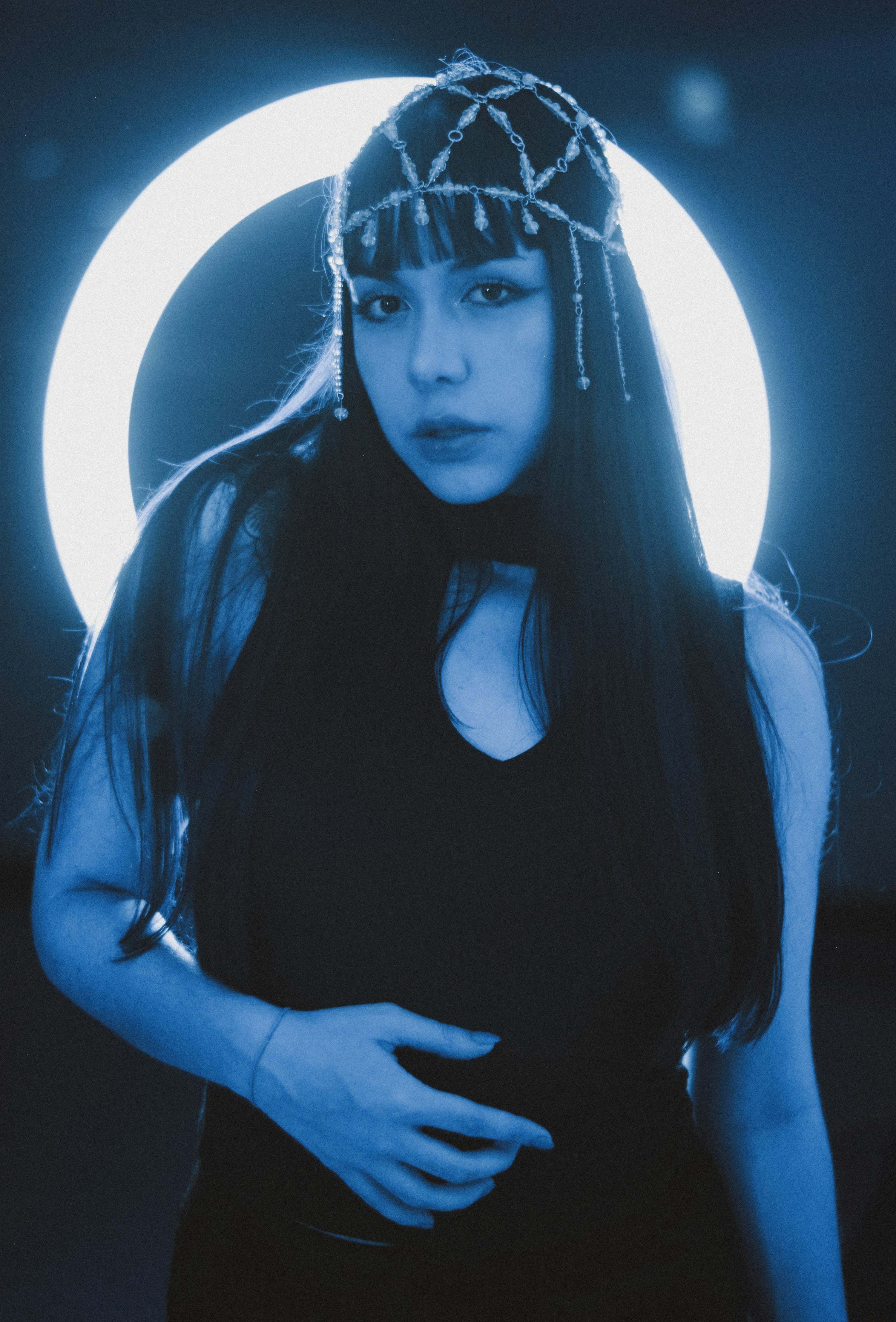 Neon Halo Portrait: A Poised Moment Beneath Circular Light