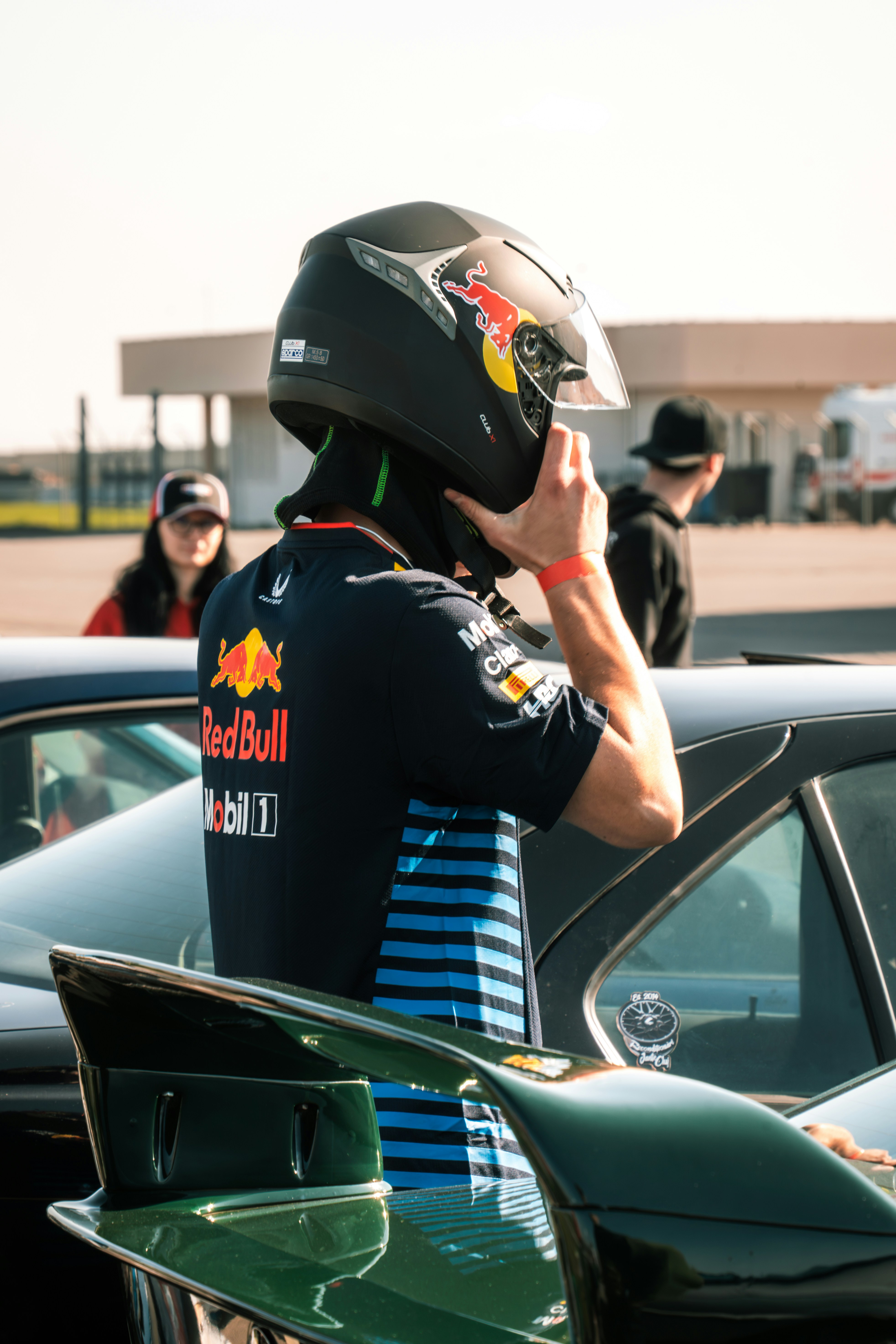 Helmeted Racer: A Quiet Moment Before the Turn