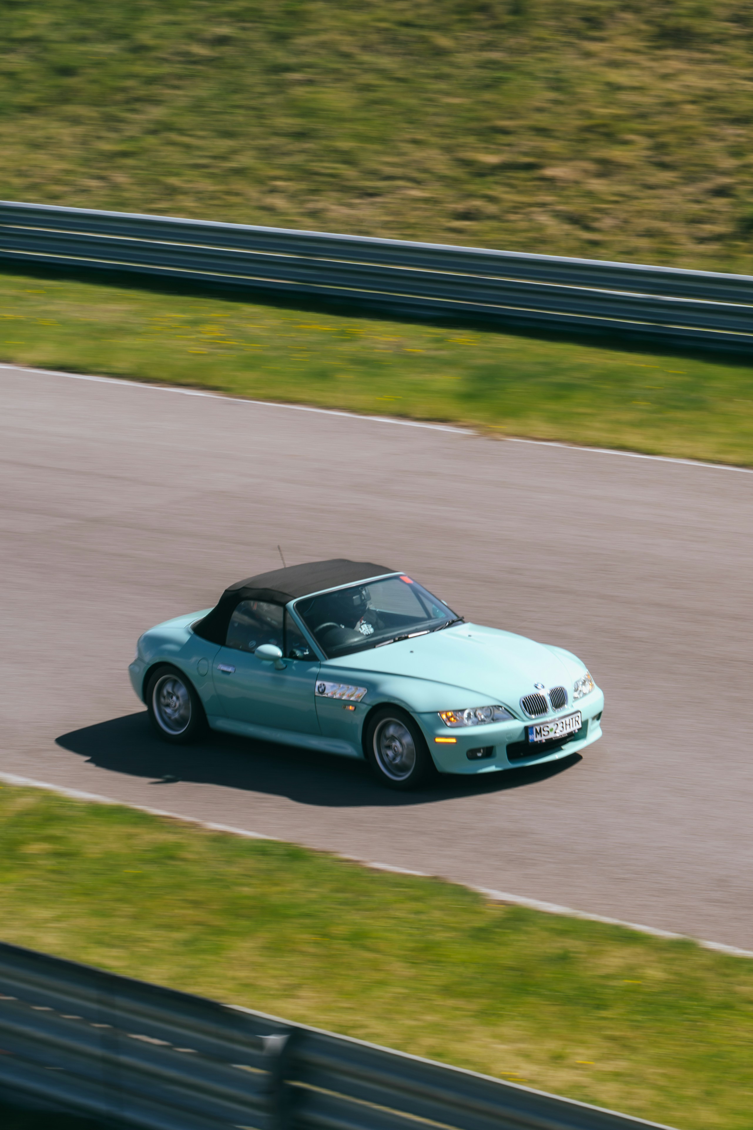 Mint Convertible on a Curved Track: A Blur of Speed