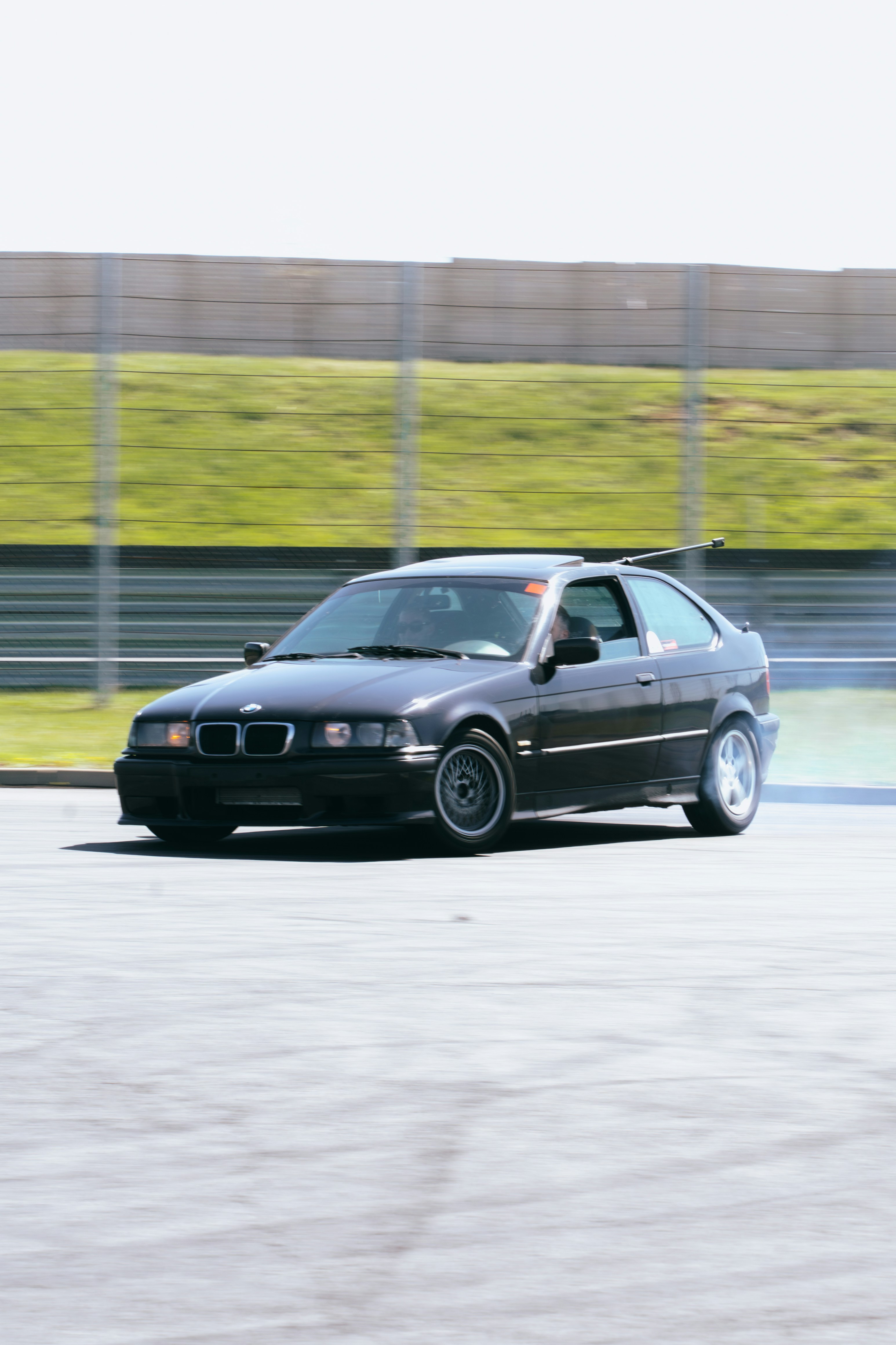 Black BMW in motion: a race-track blur of power and control