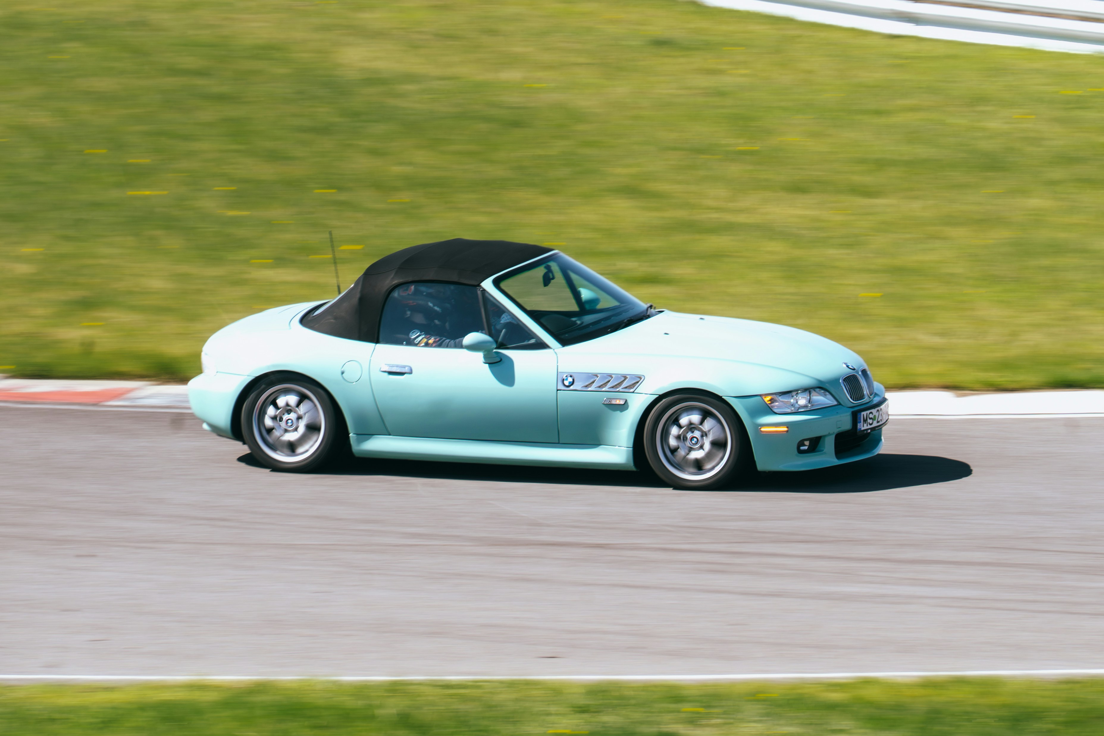 Azure Roadster in Motion: A Convertible Leap on the Track