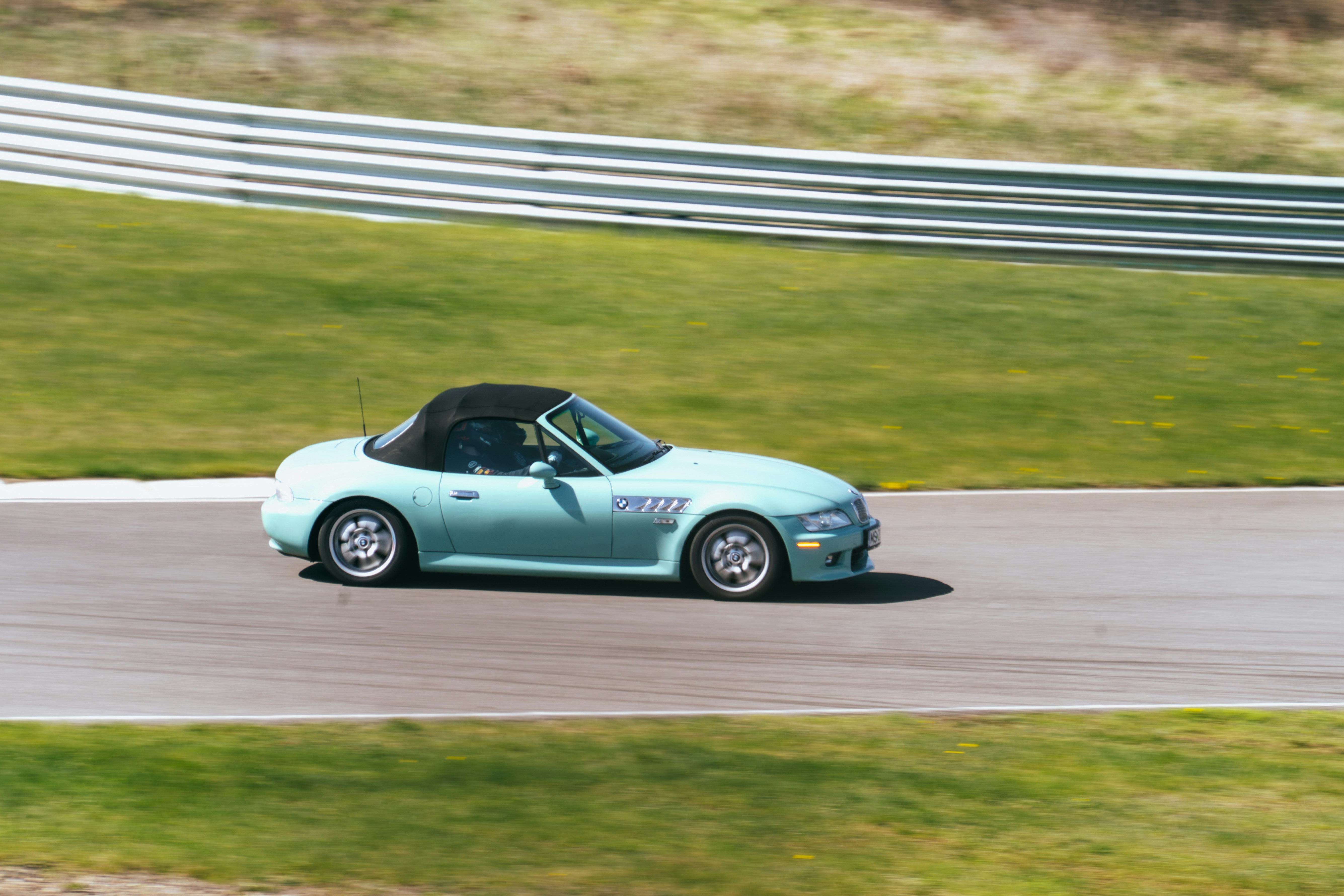 Mint Green Deftness: A Convertible Racer in Motion