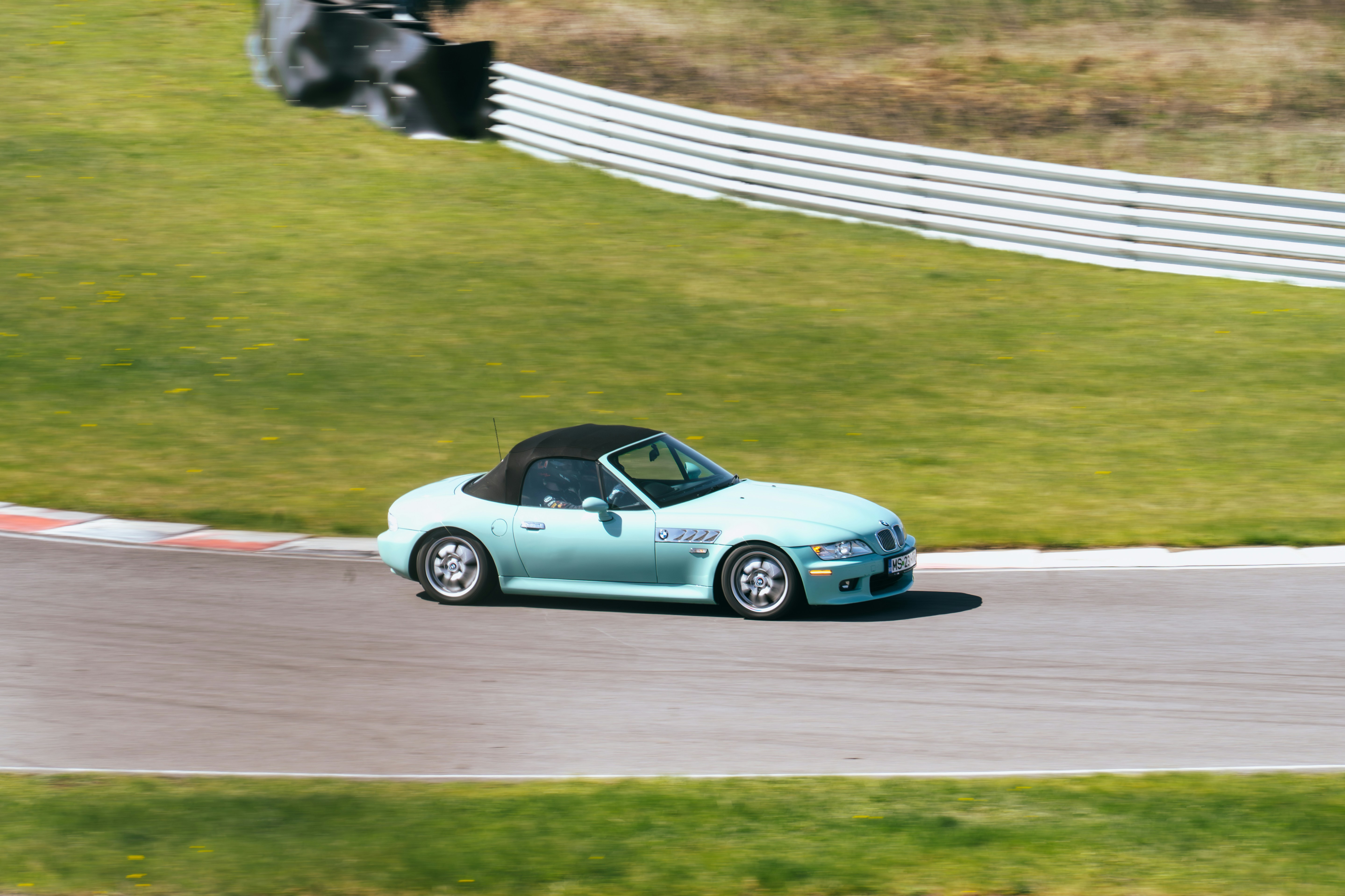 Mint Convertible in Motion: A Sunny Track Escape