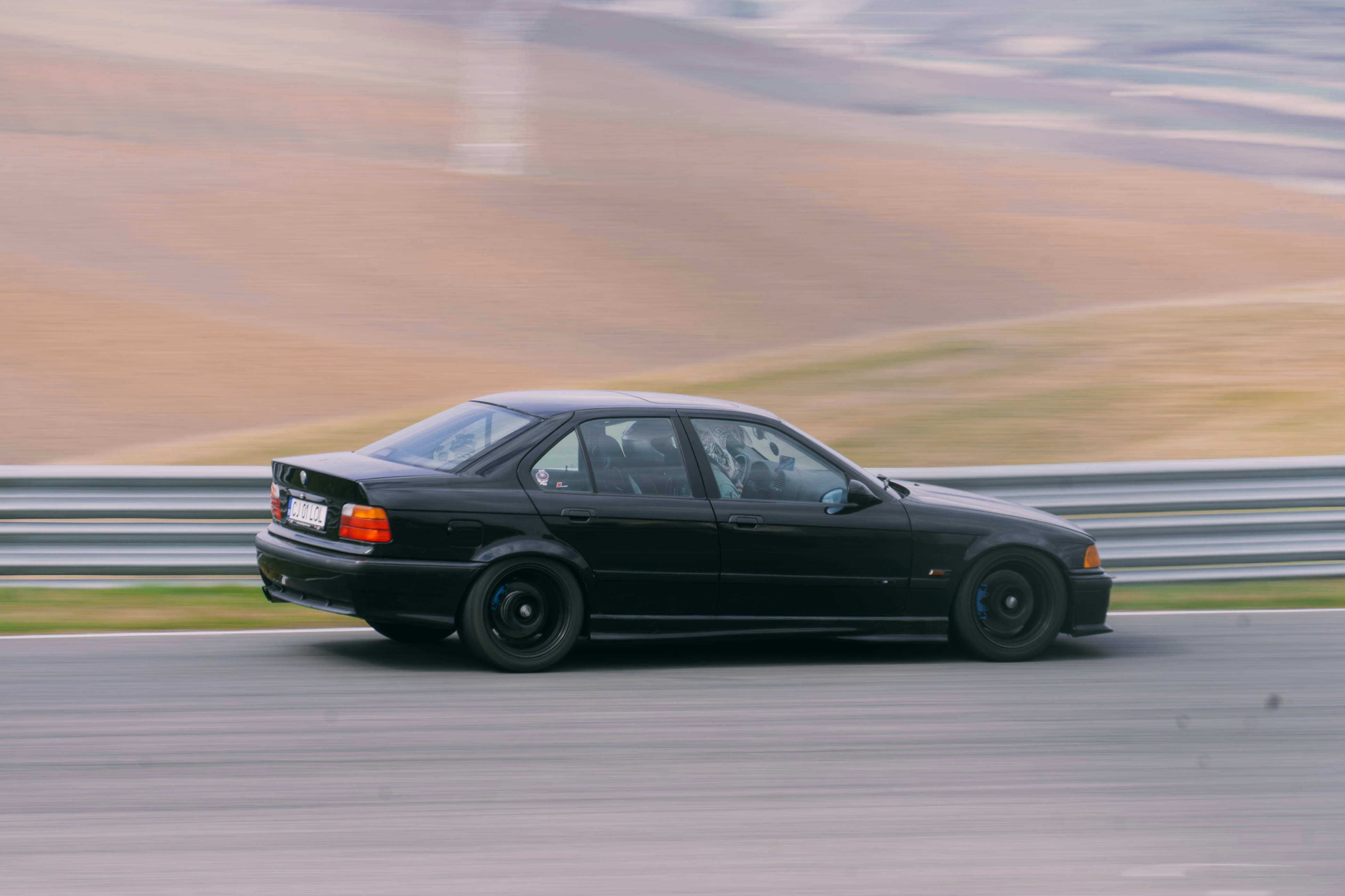 Black sedan in motion: a blurred highway sprint