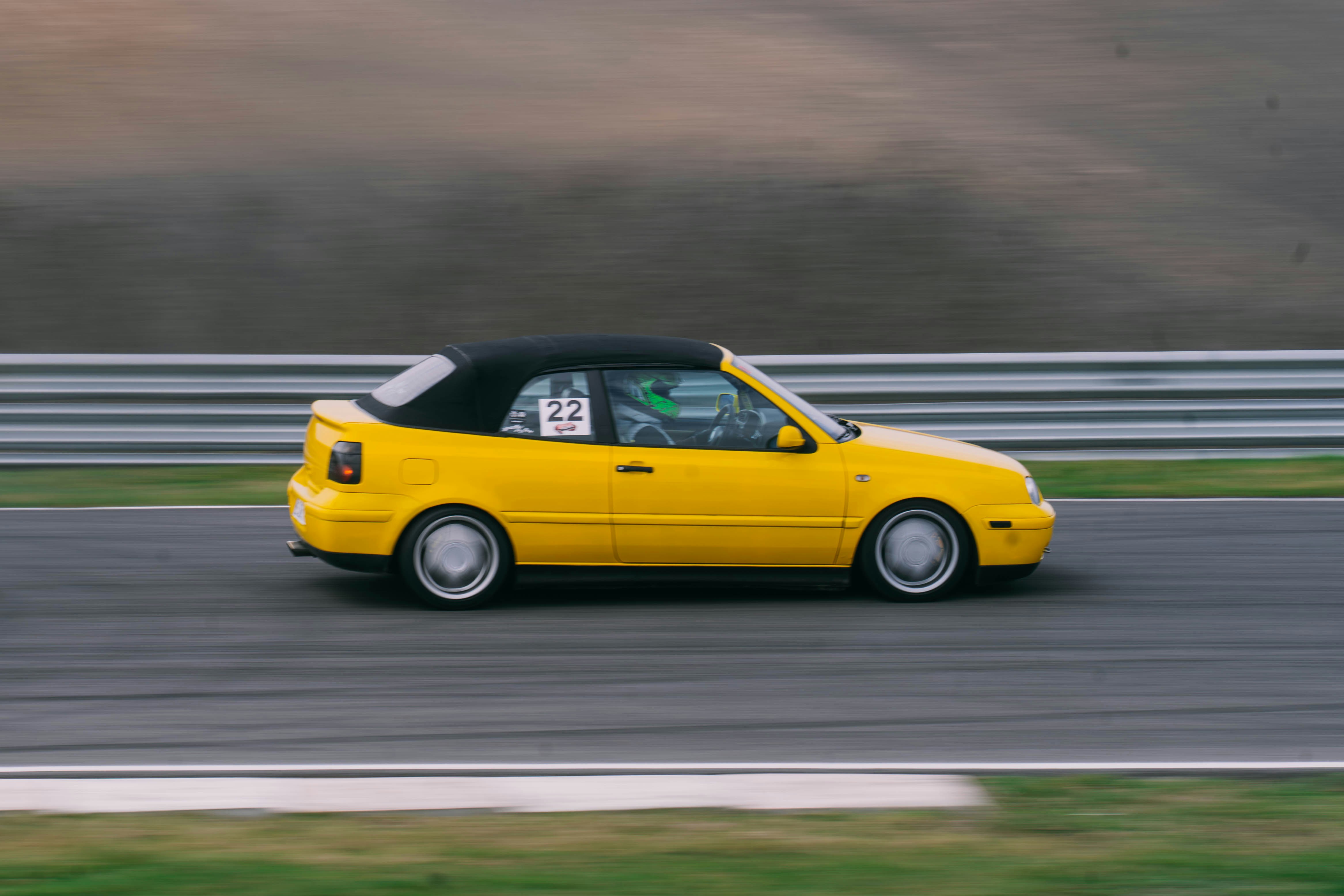 Yellow Hatchback in a Blur of Speed on the Track
