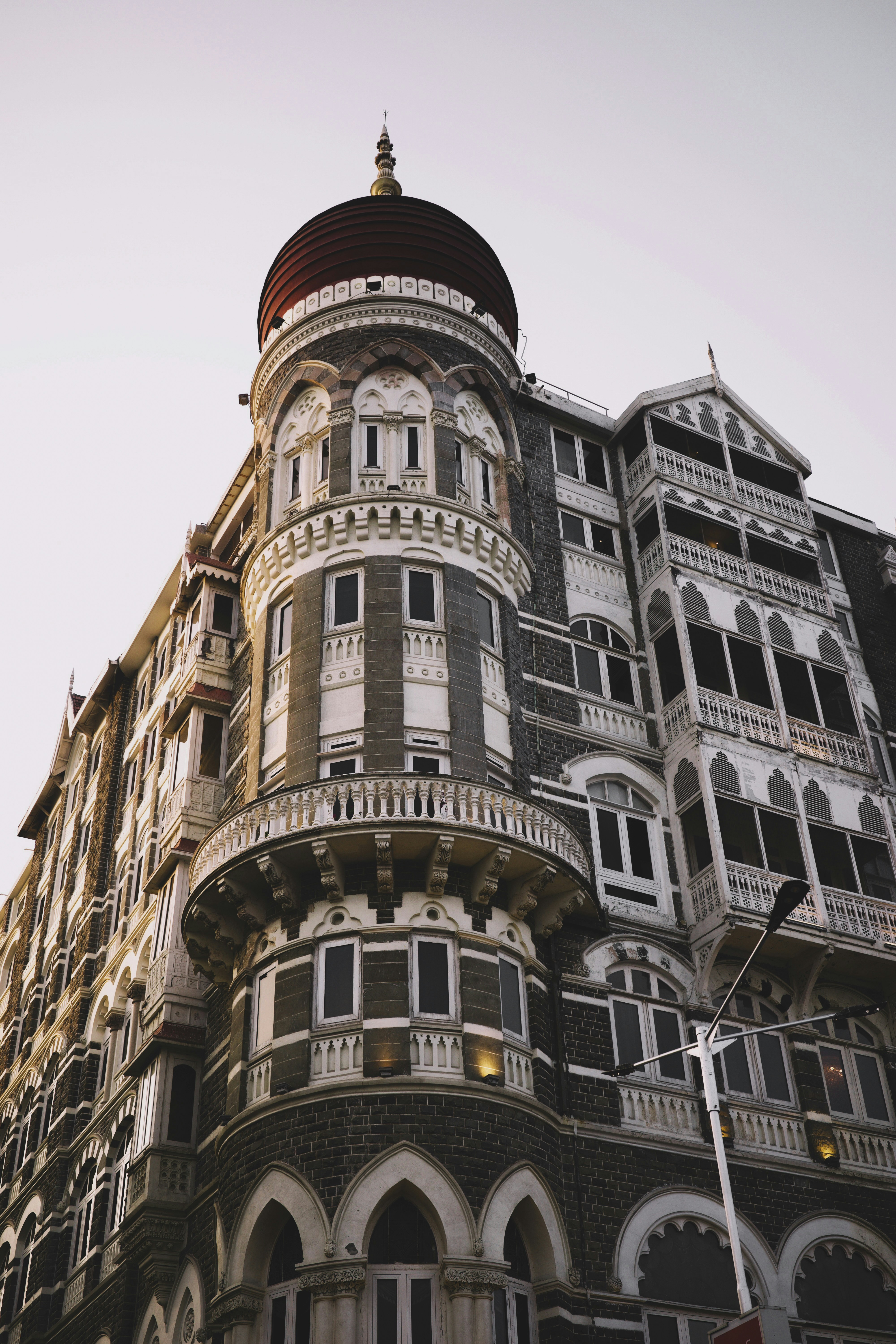 Turreted Facade: A Gothic-Style Corner Tower Rising Over The City