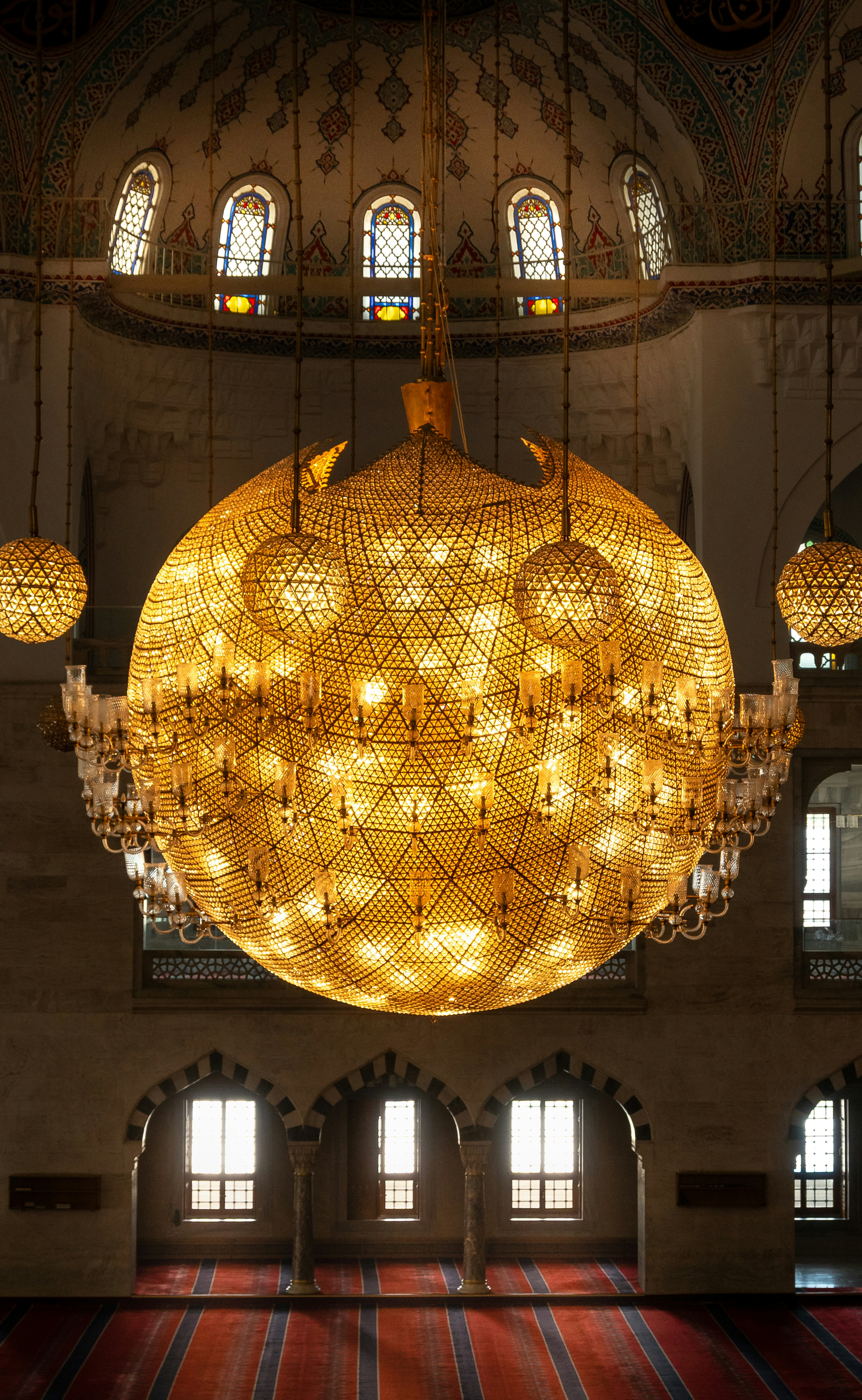 Golden Sphere of Light: A Grand Chandelier Inside a Historic Hall