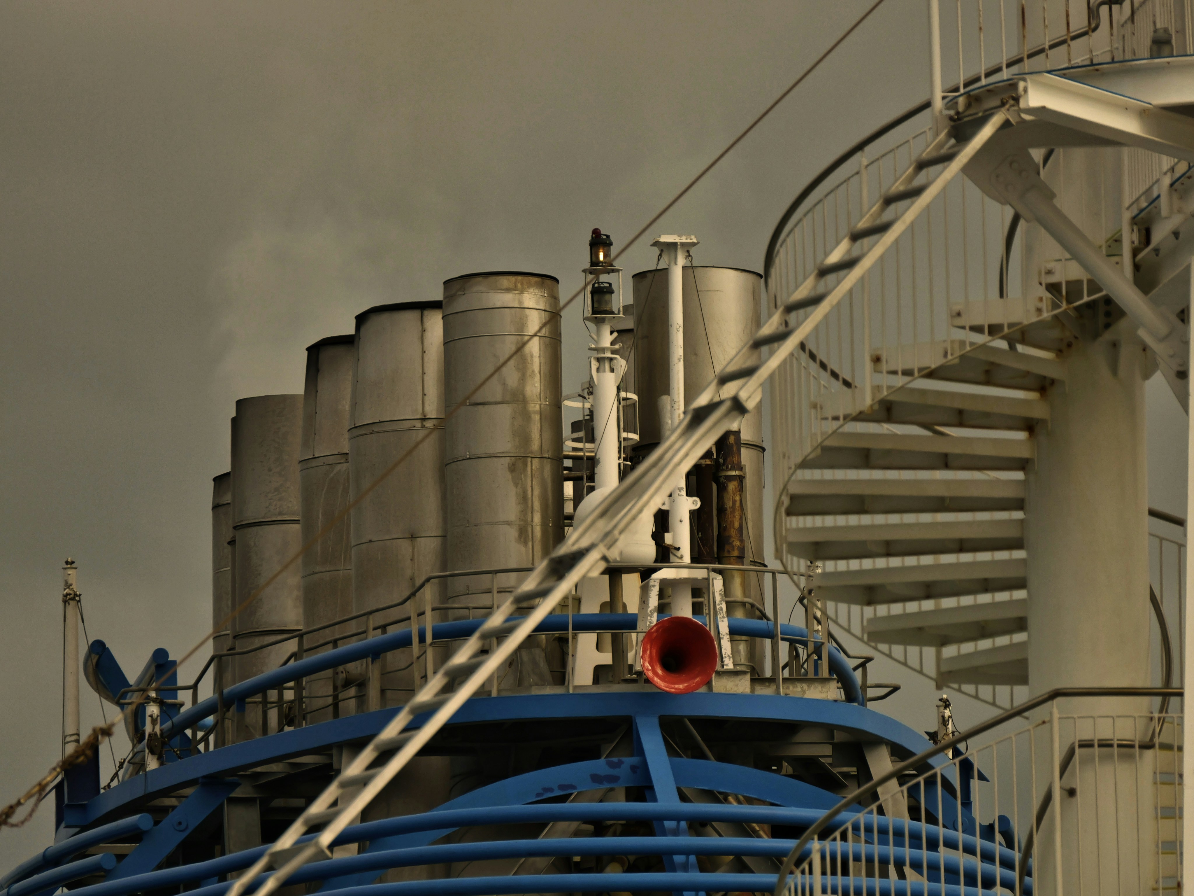 Blue Boiler Crown: Industrial Silhouettes Under a Smoky Sky