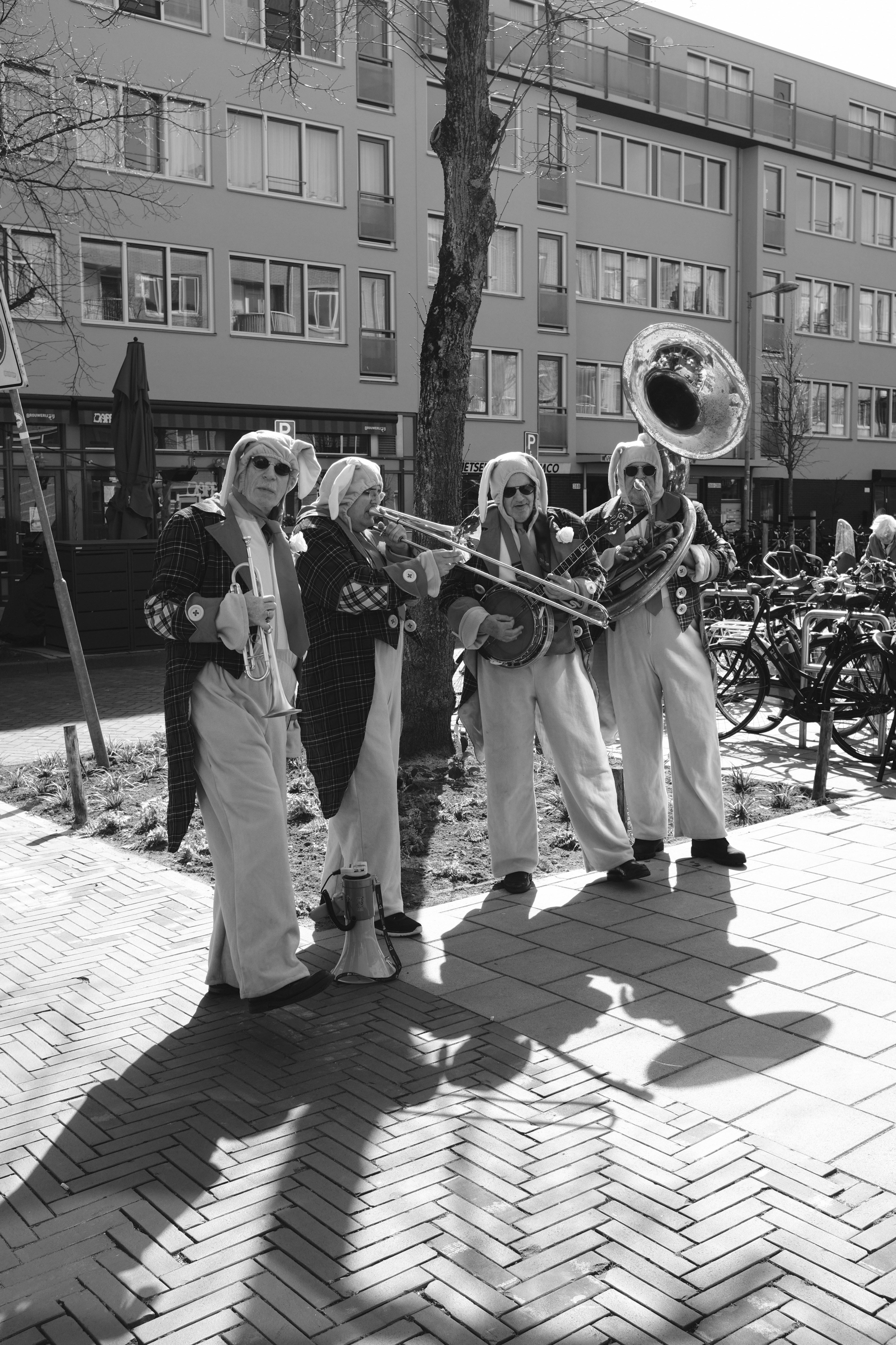 Brass in the Street: A Small Green Band Plays Outside a Modern Block